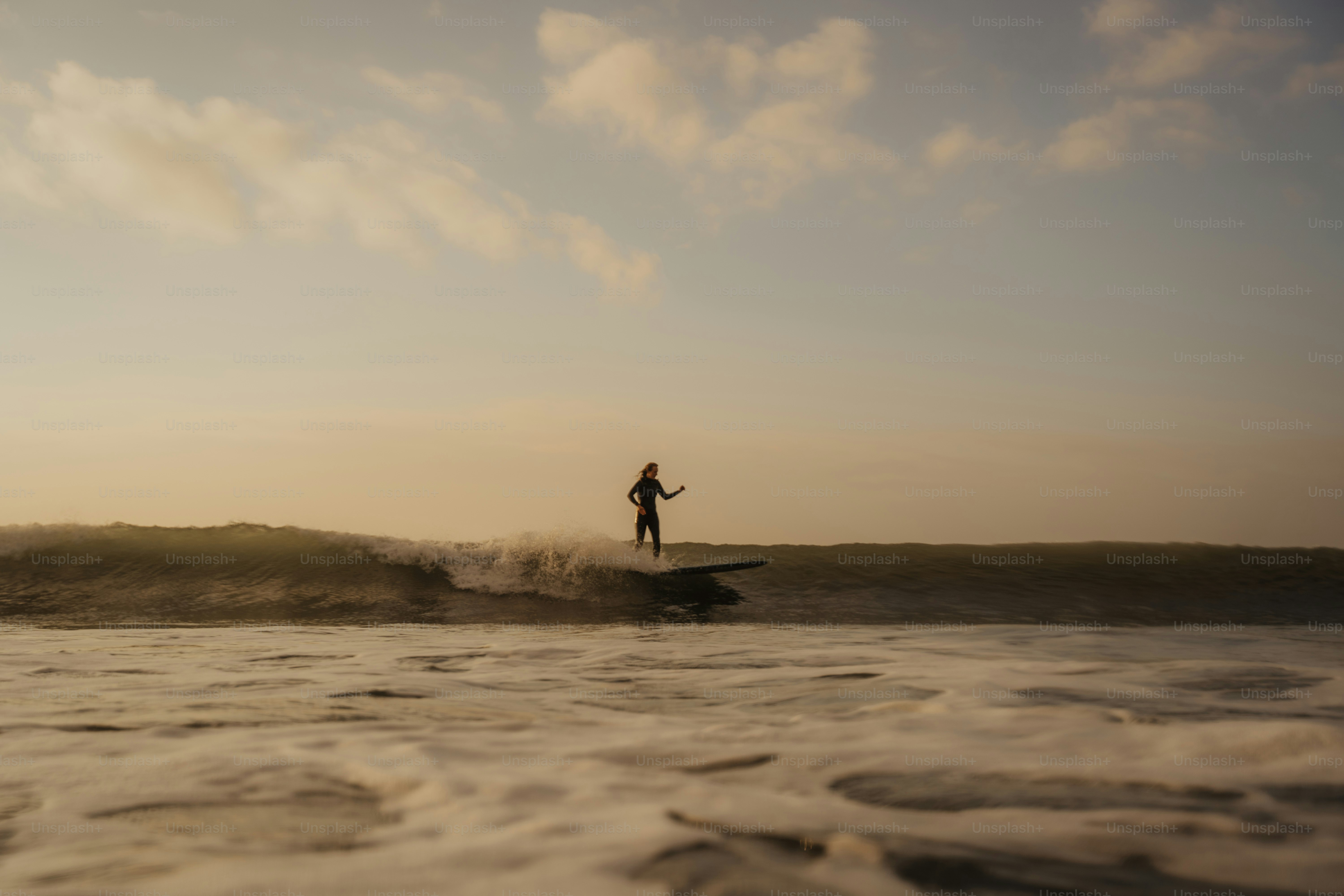Um homem surfando uma onda em cima de uma prancha de surf foto – Imagem ...