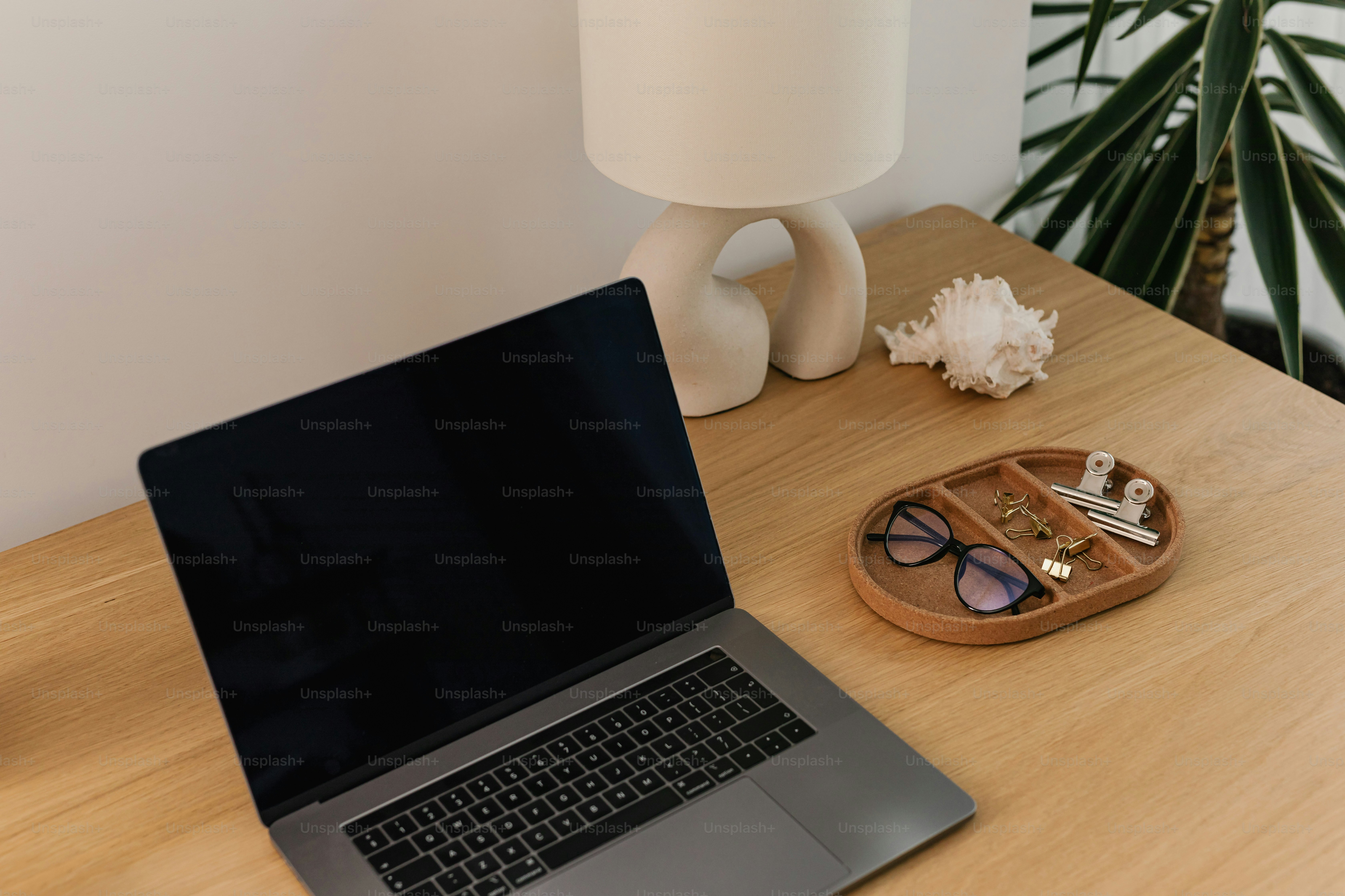 A laptop computer sitting on top of a wooden desk photo – Interior ...