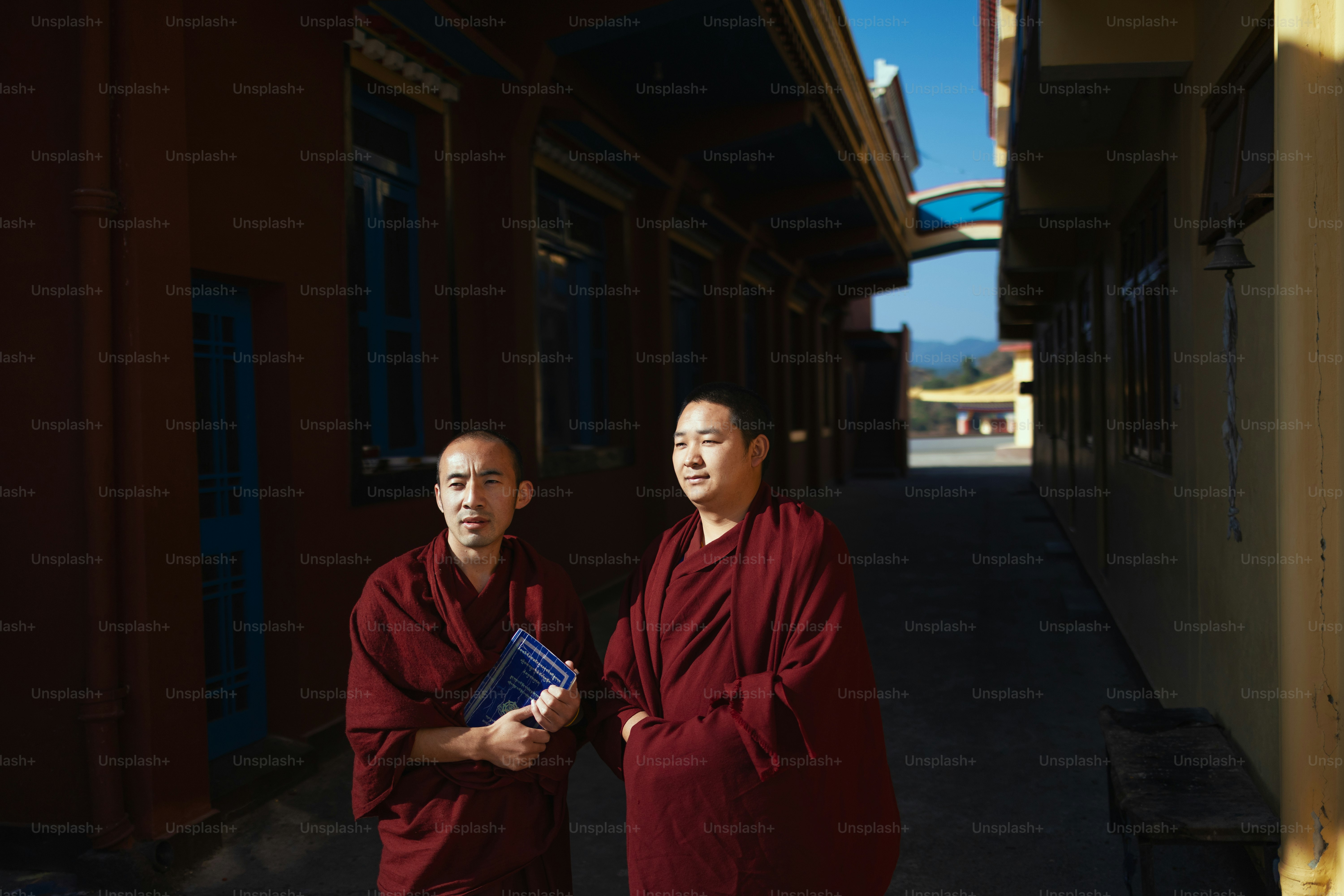 A couple of men standing next to each other photo – The menri monastery ...