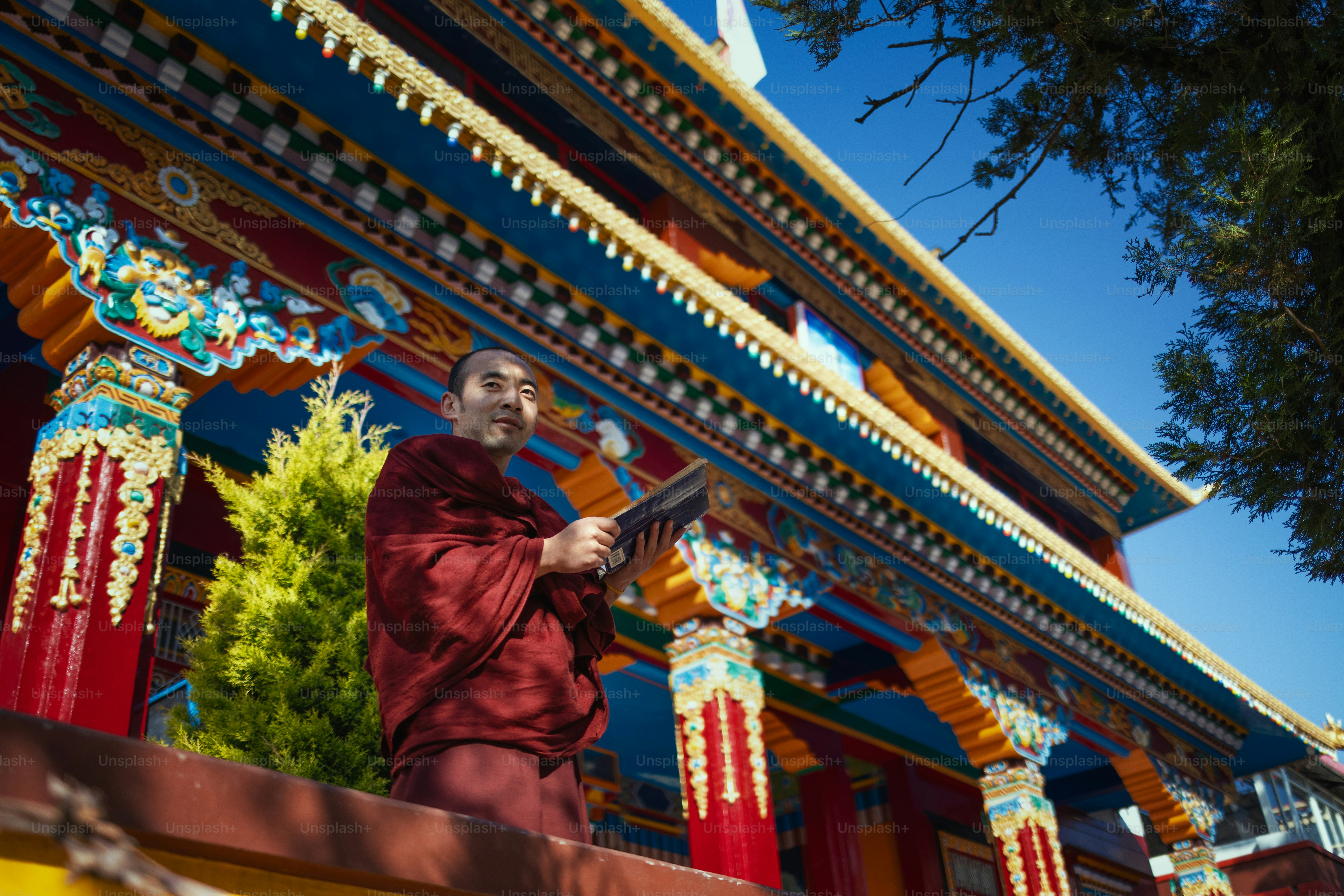 Two monks walking up a set of stairs photo – The menri monastery Image ...