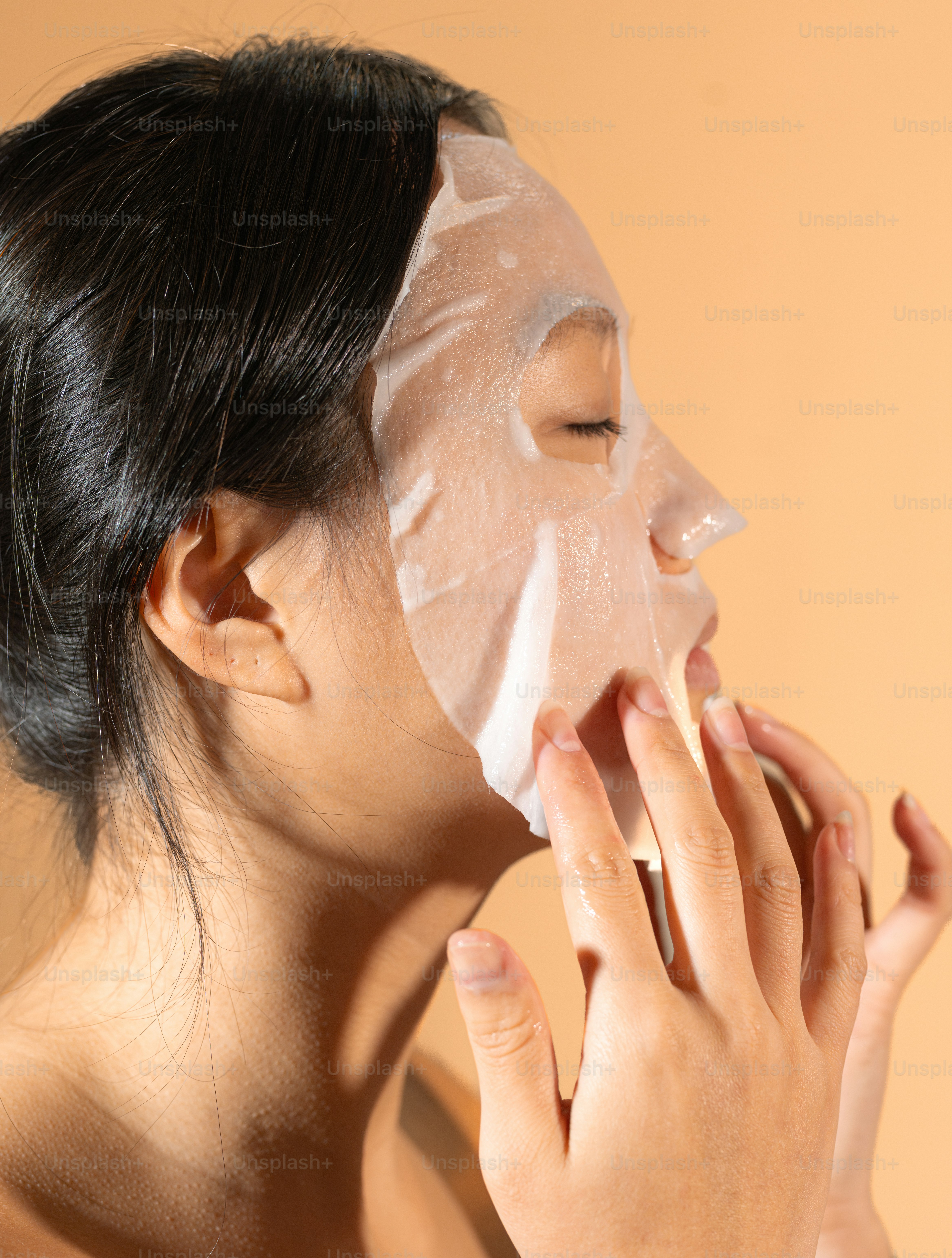 A woman with a sheet of plastic covering her face photo – Facemask ...