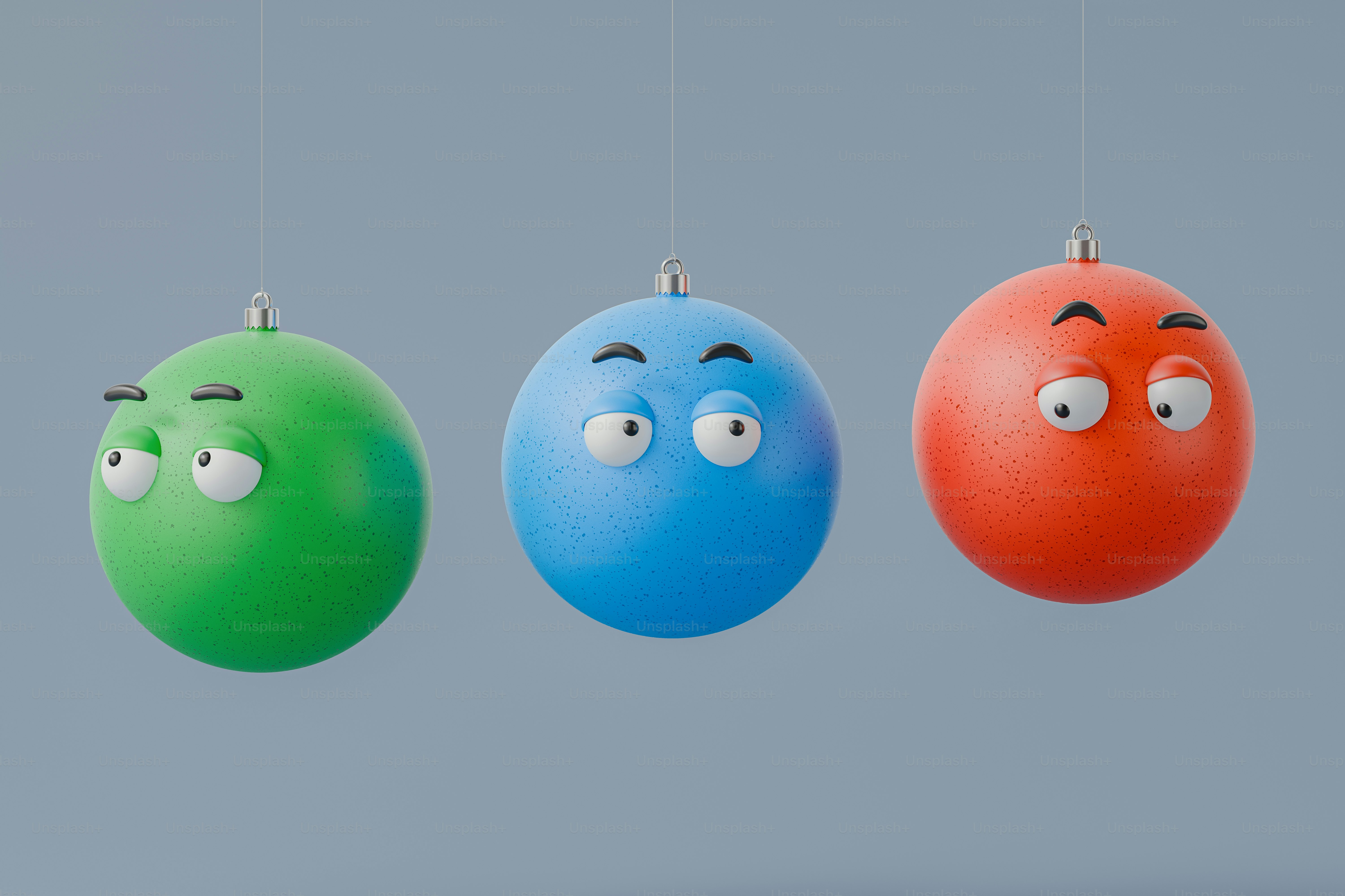 Three balls with faces hanging from strings photo – Cartoon Image on ...