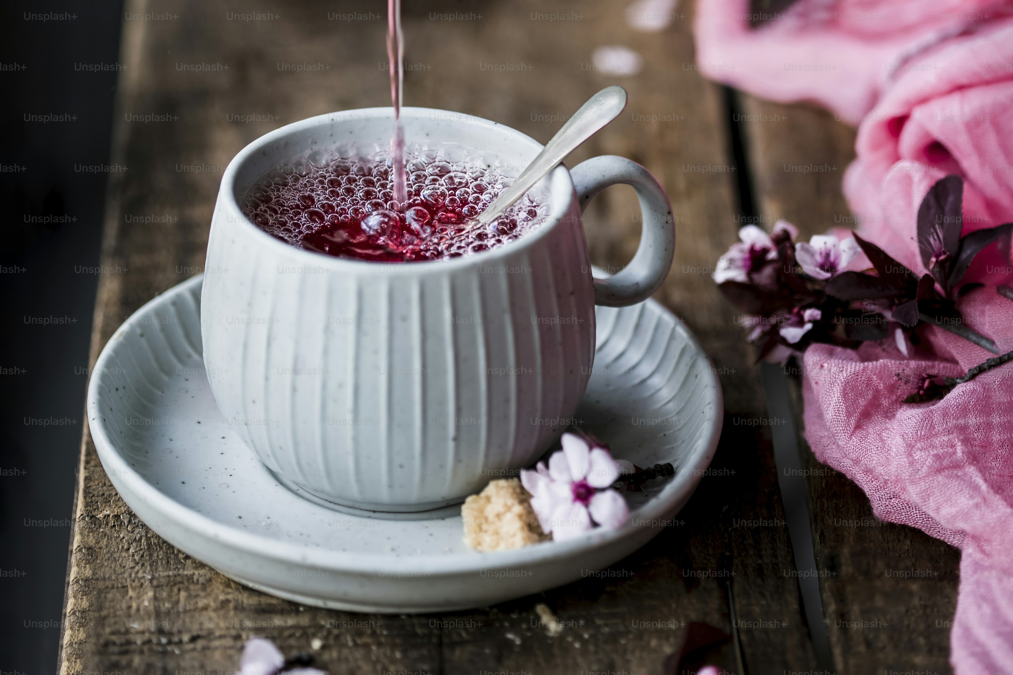 A cup filled with liquid sitting on top of a saucer photo – Tea time ...