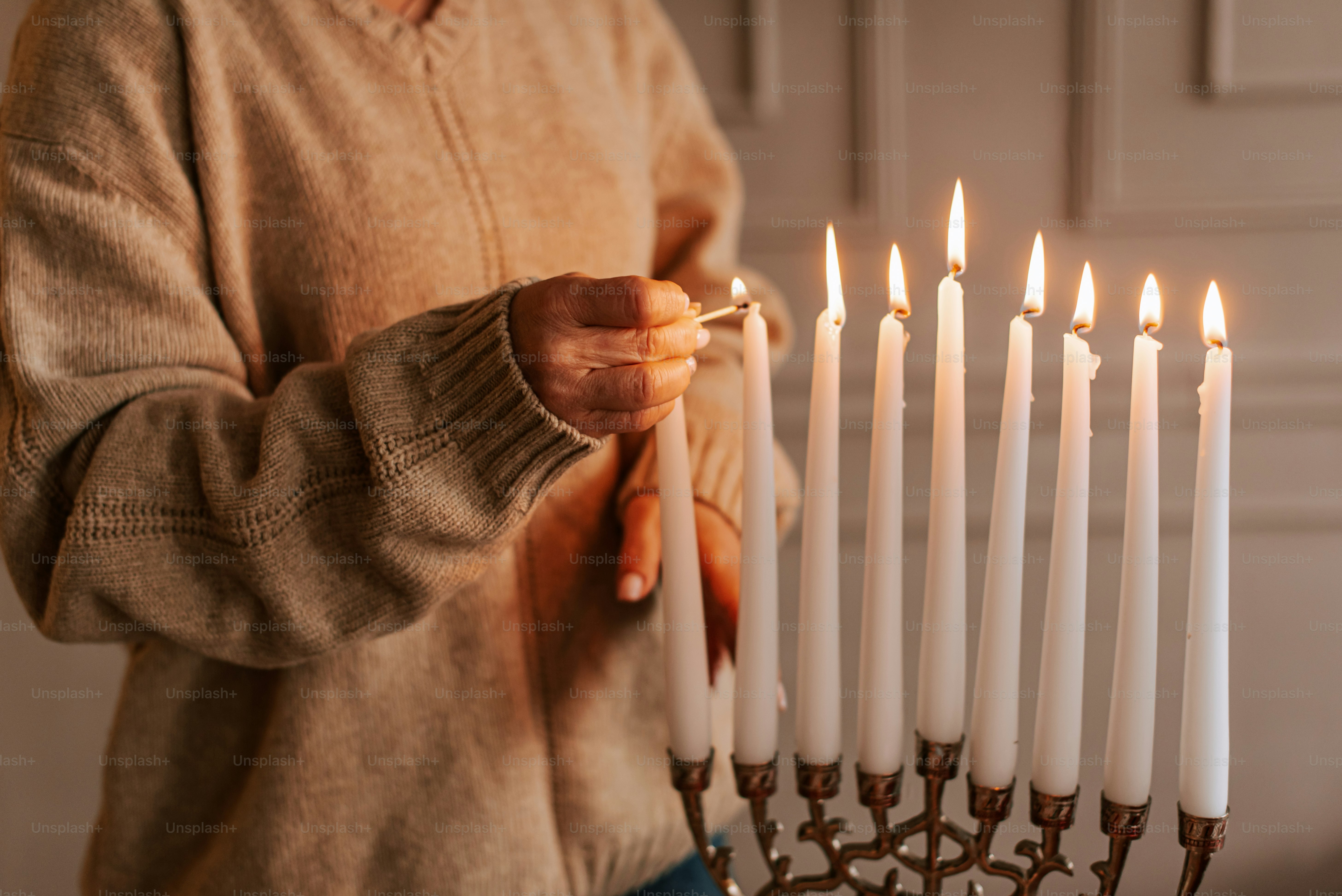 A woman lighting a menorah with candles photo – Food Image on Unsplash