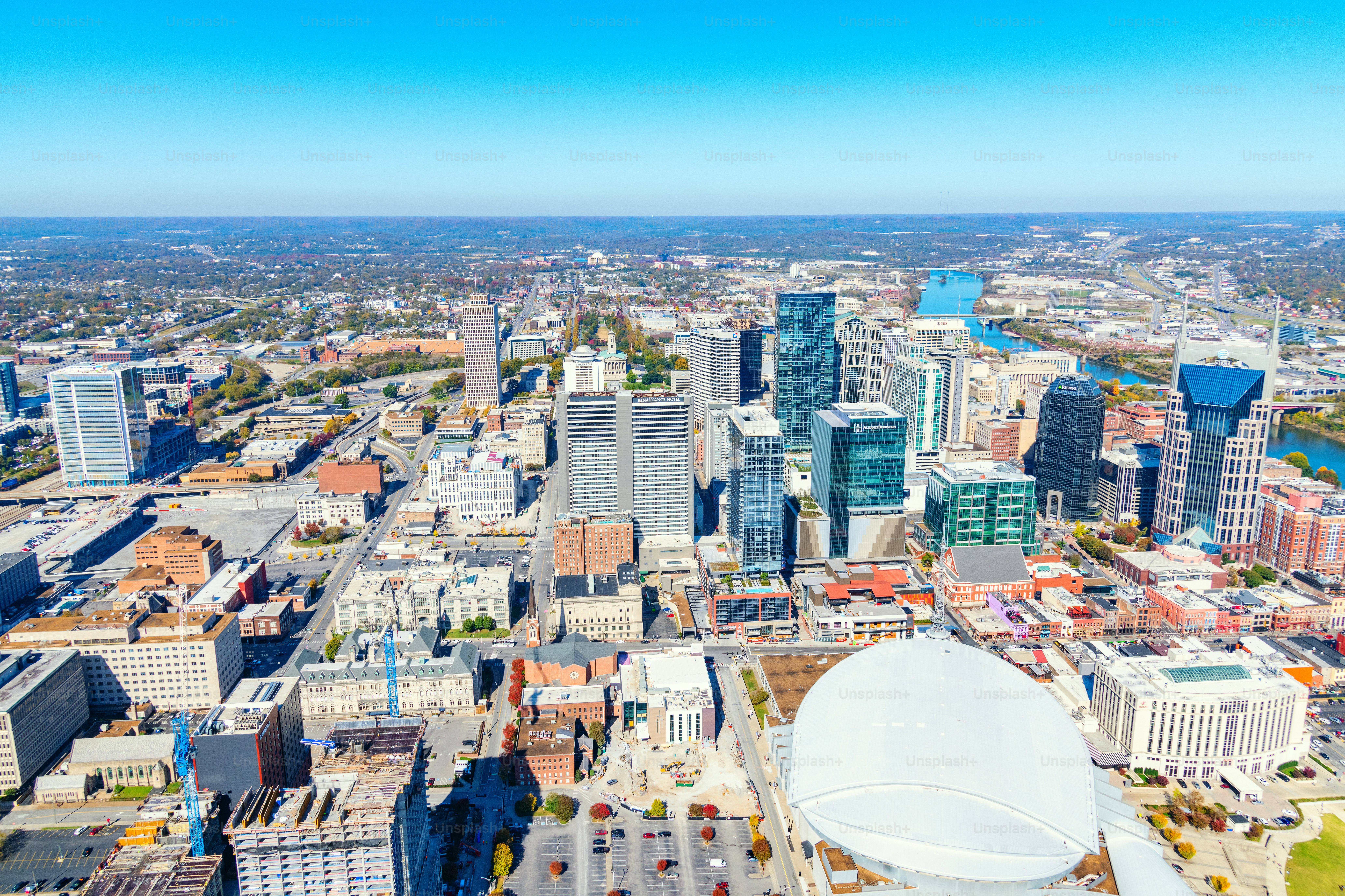 The skyline of Nashville, Tennessee along the banks of the Cumberland ...