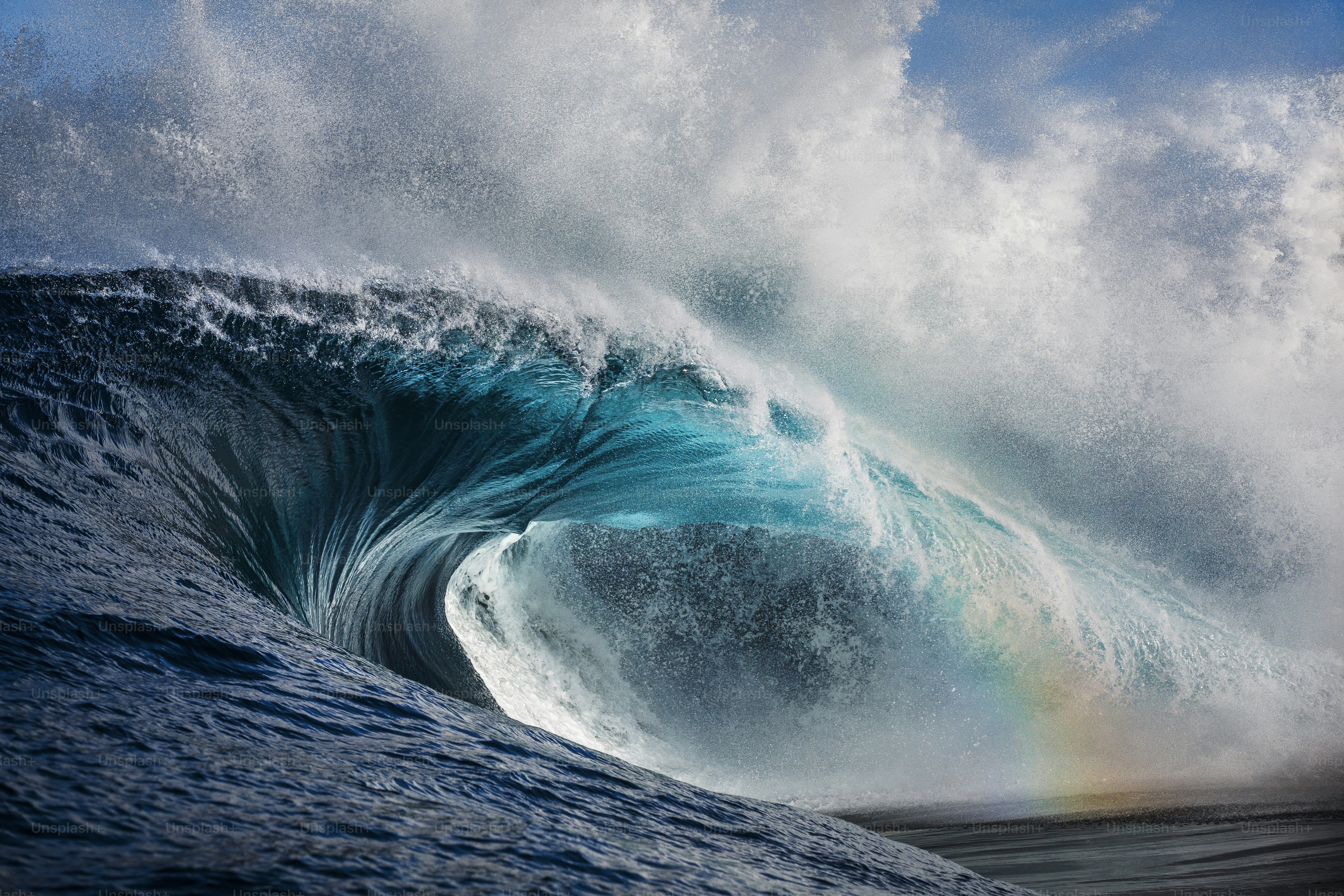 Powerful crashing ocean wave with hint of rainbow shining through photo ...