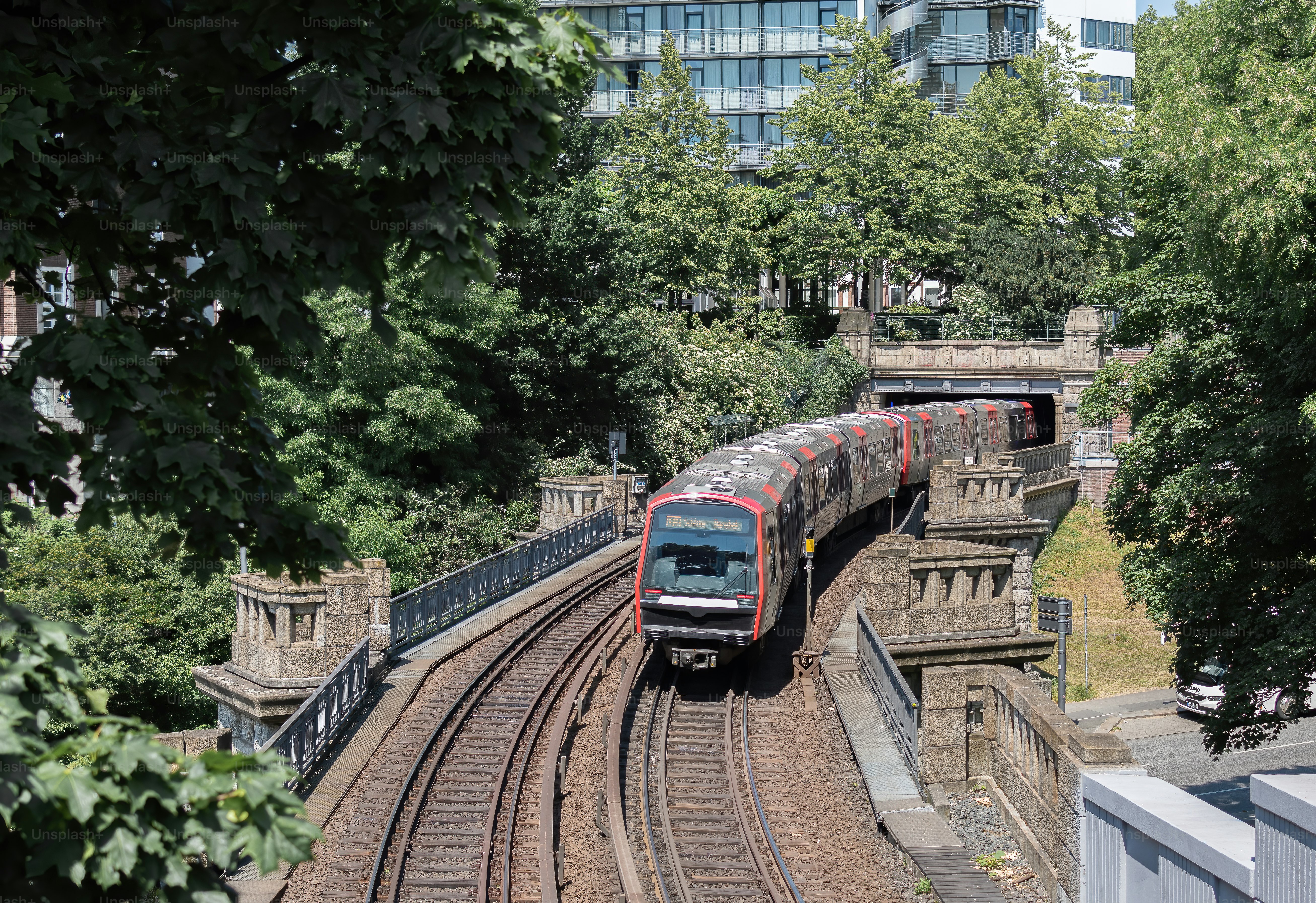 Train (Hamburg Rapid Transit System) passing bridge and enters the ...