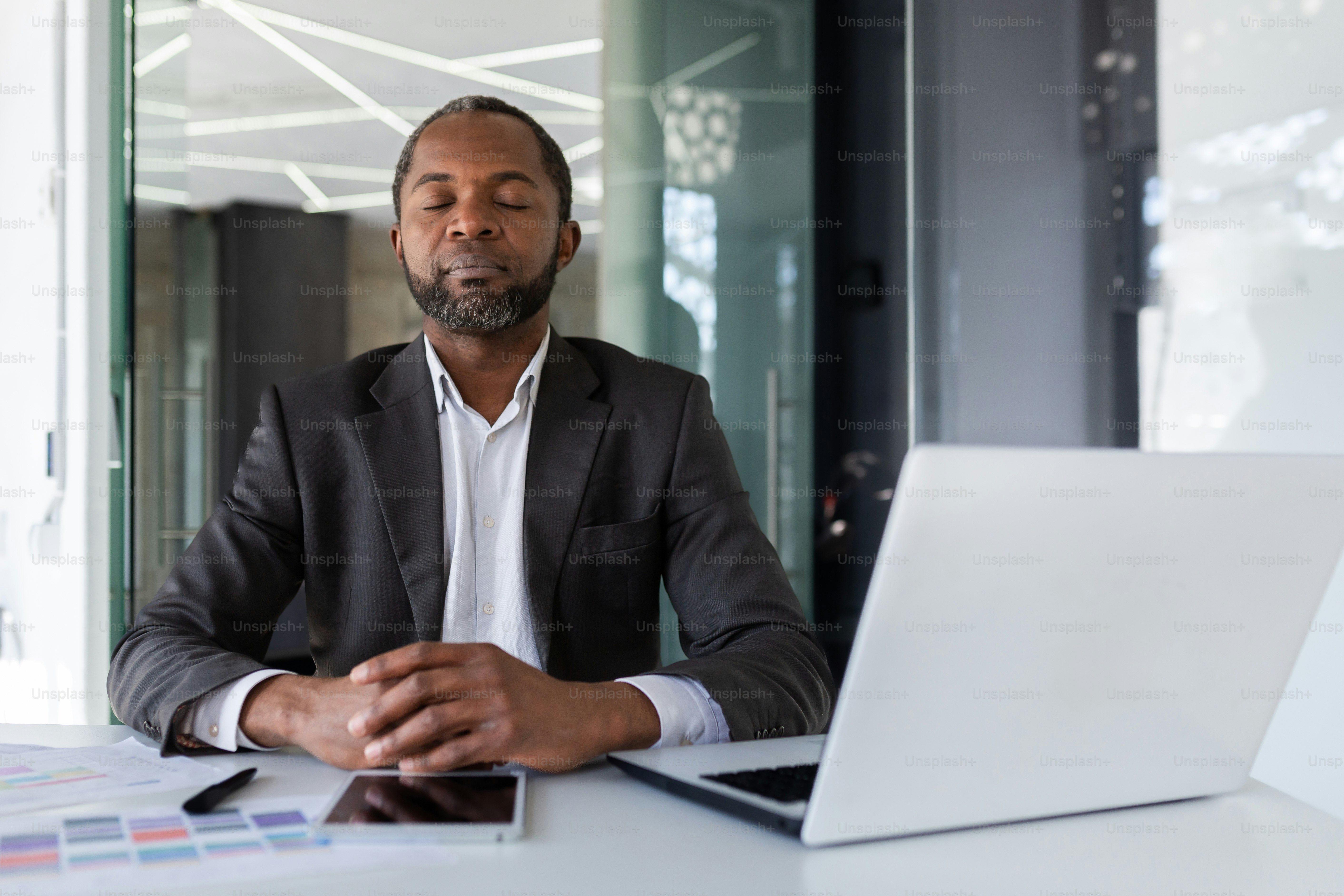 Balanced and calm man at workplace inside office, businessman ...