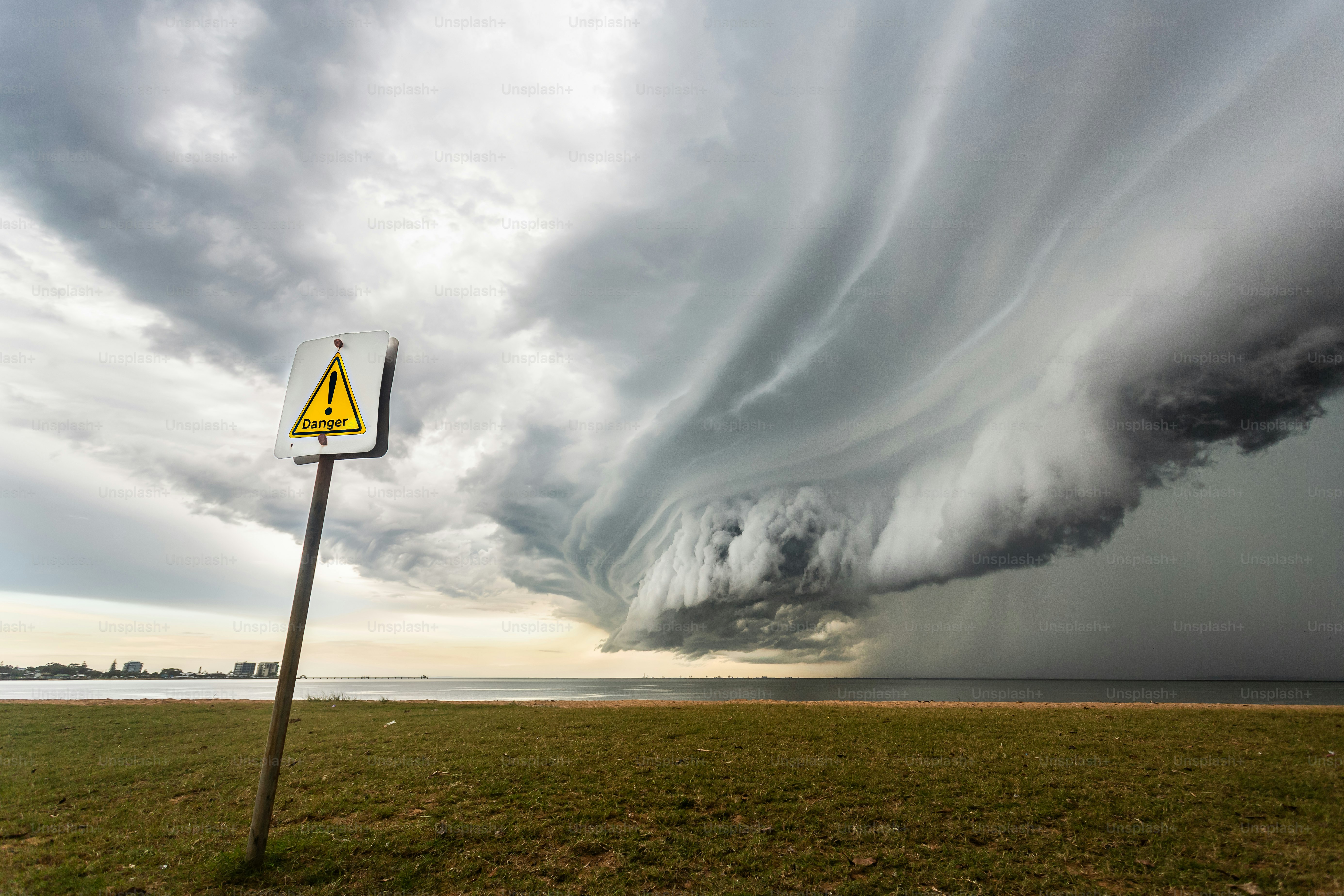 A scary looking huge shelf cloud coming in from the ocean with a danger ...