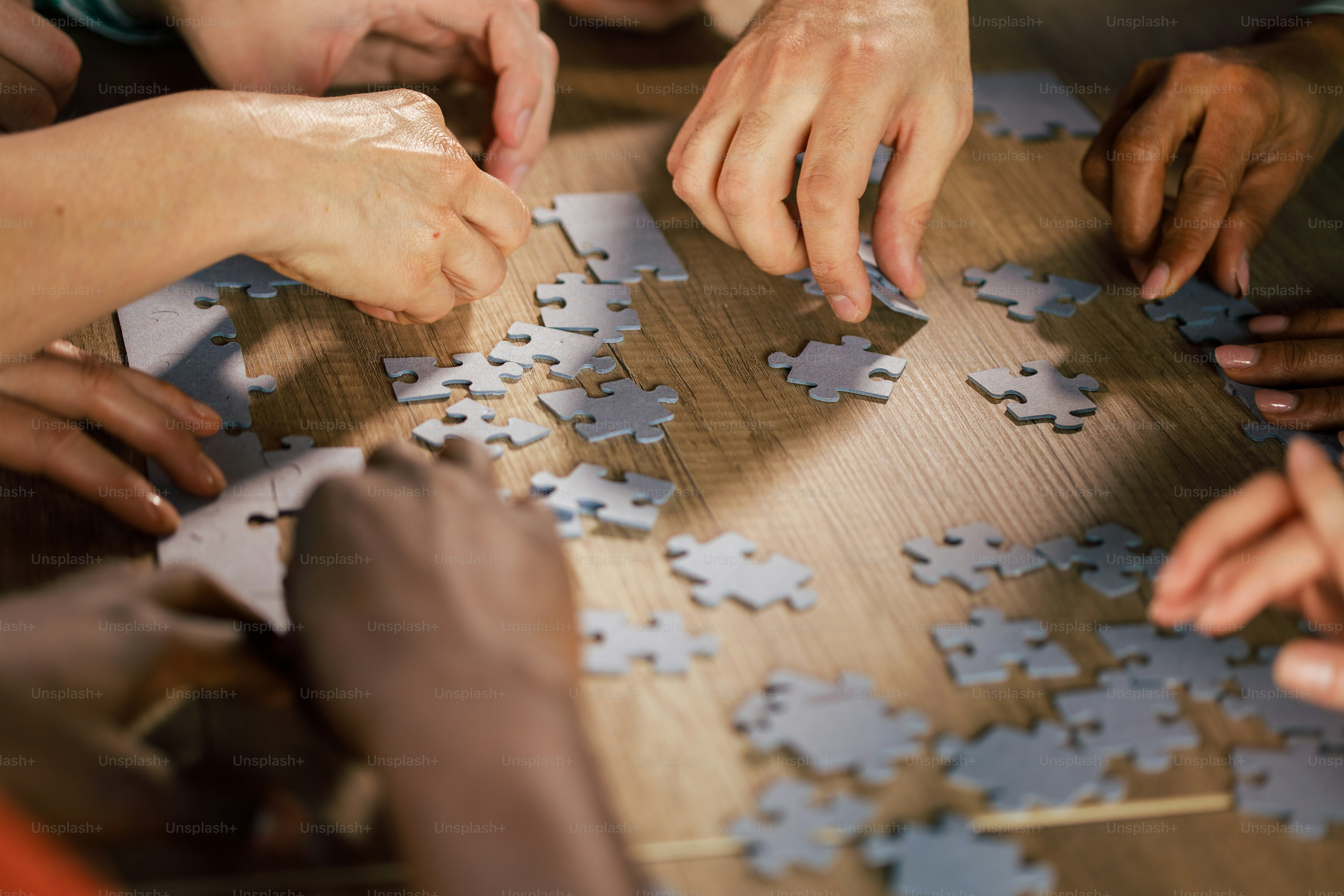Business experts engrossed in puzzle discussion at the table. photo ...