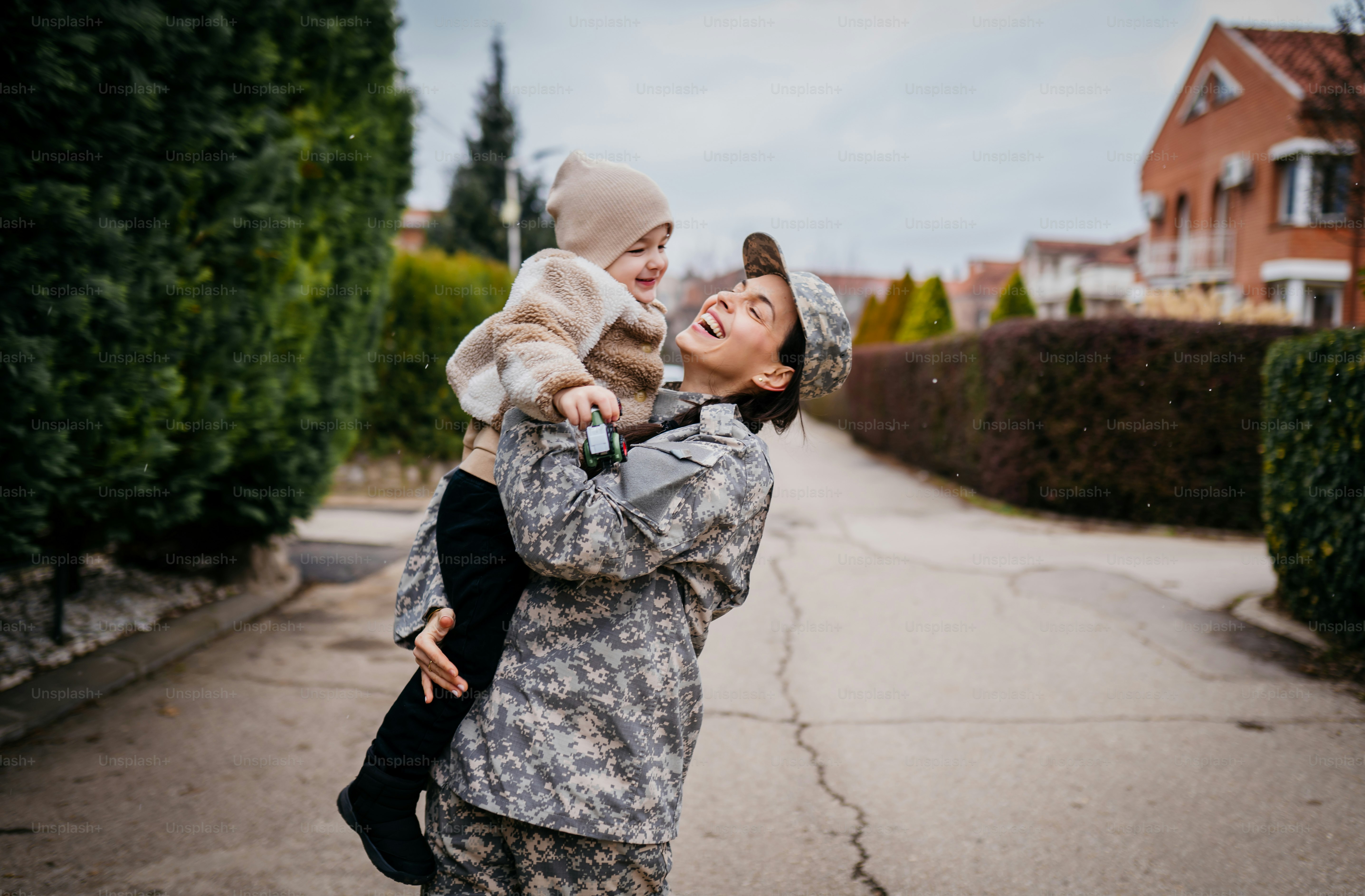 Excited military mom embracing her son after returning home from the ...