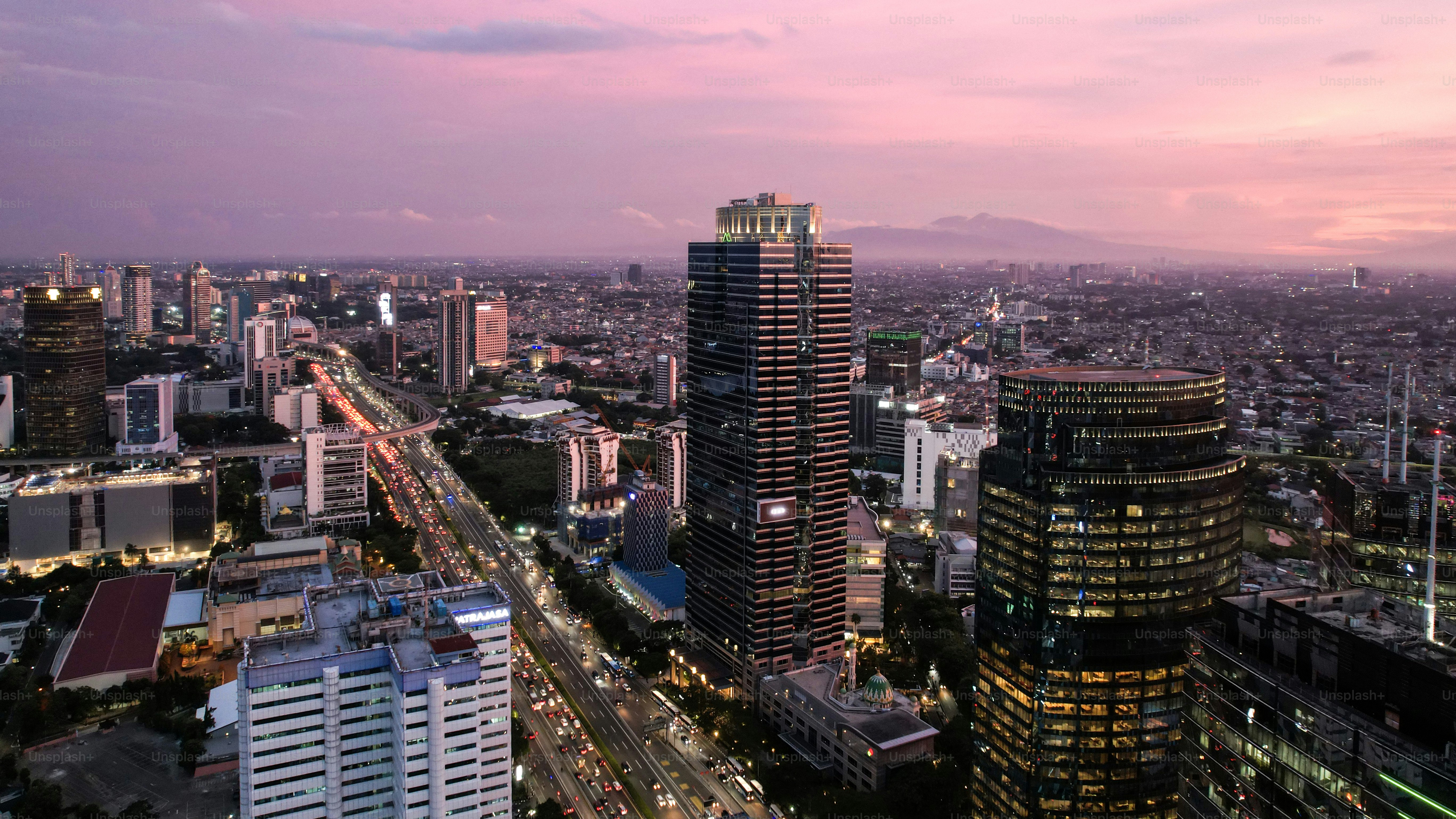 Panoramic cityscape of Indonesia capital city Jakarta at sunset. A rare ...