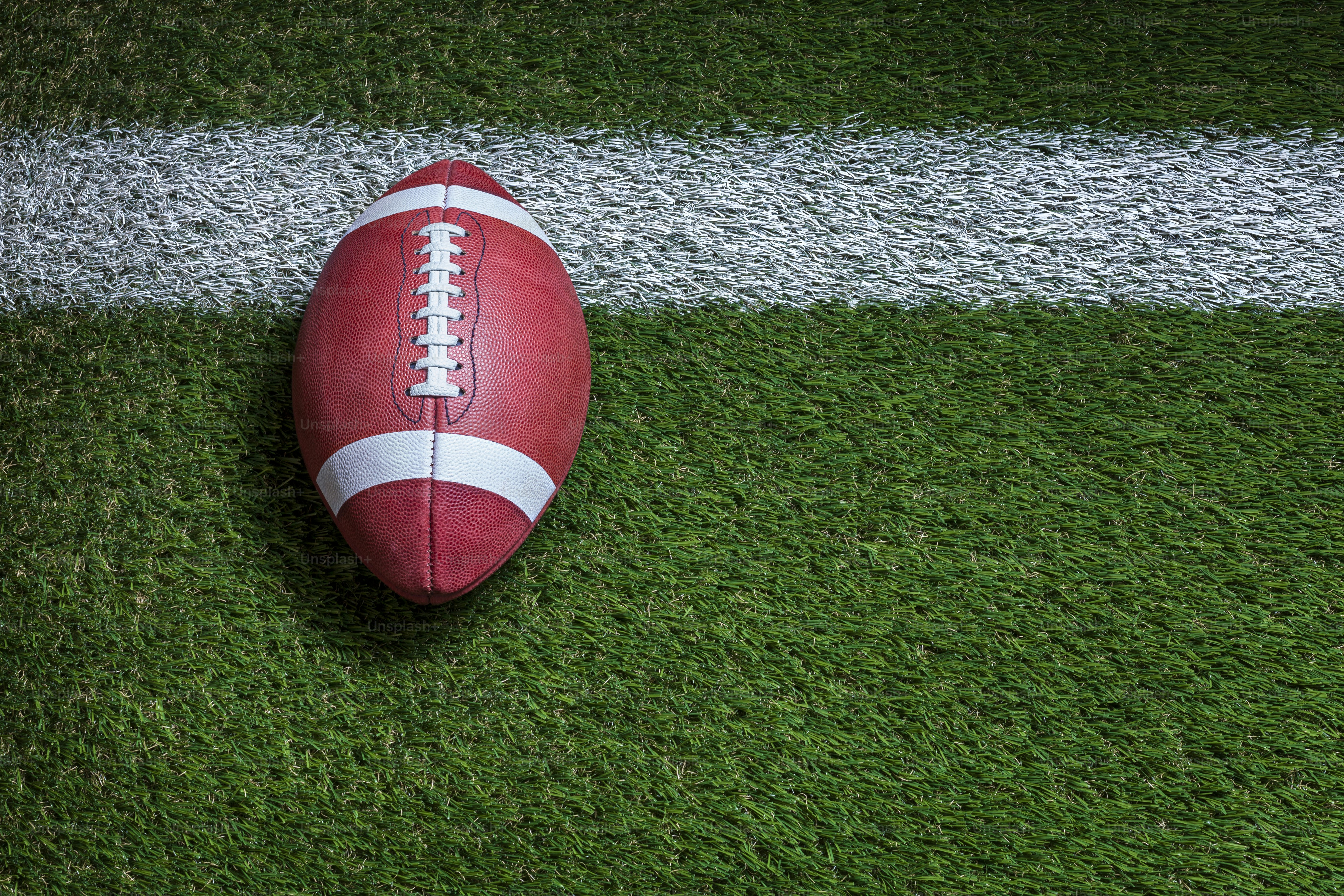Football at the goal line on a grass field overhead view photo ...