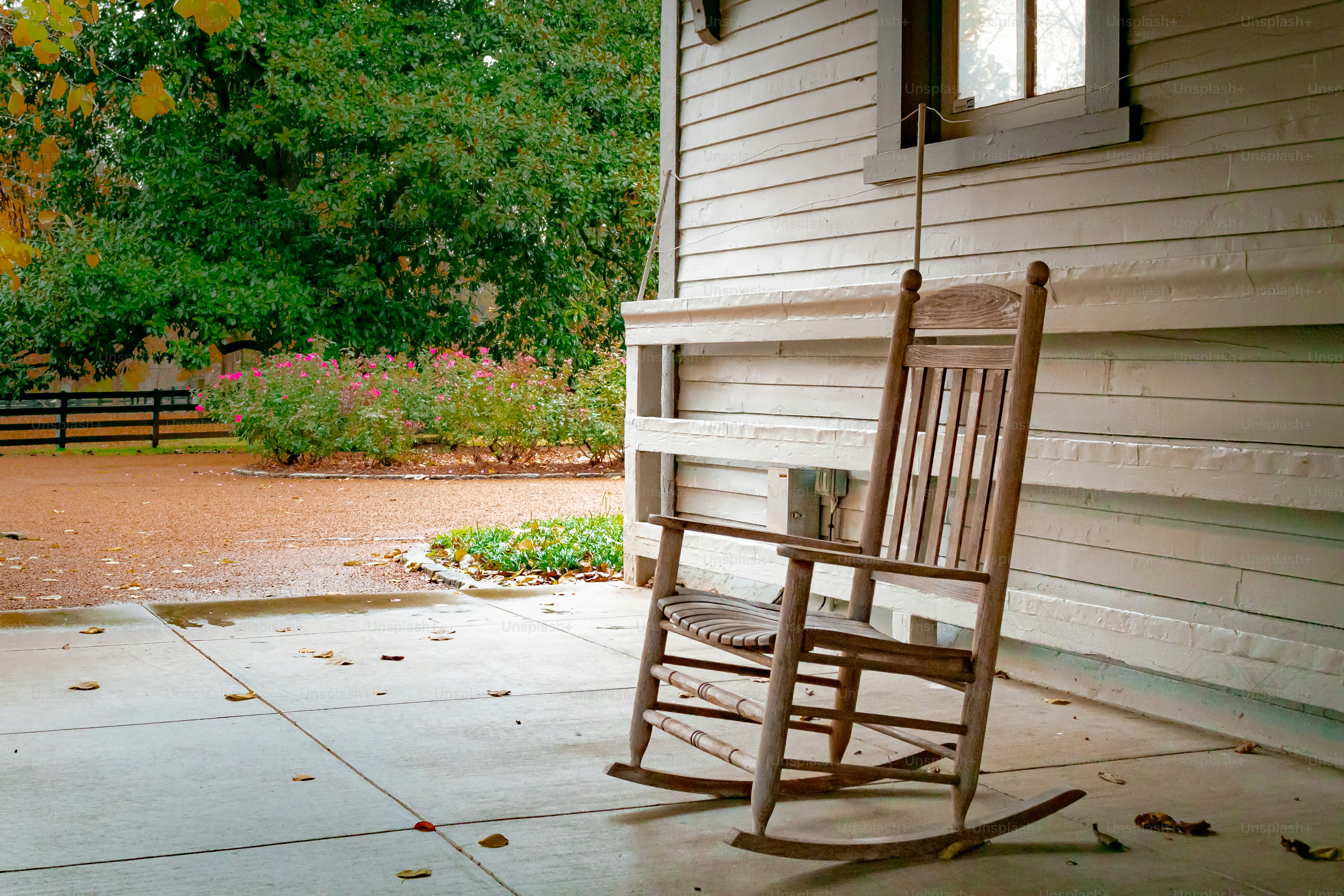 Wooden rocking chair next to a building outdoors. Photo taken in ...