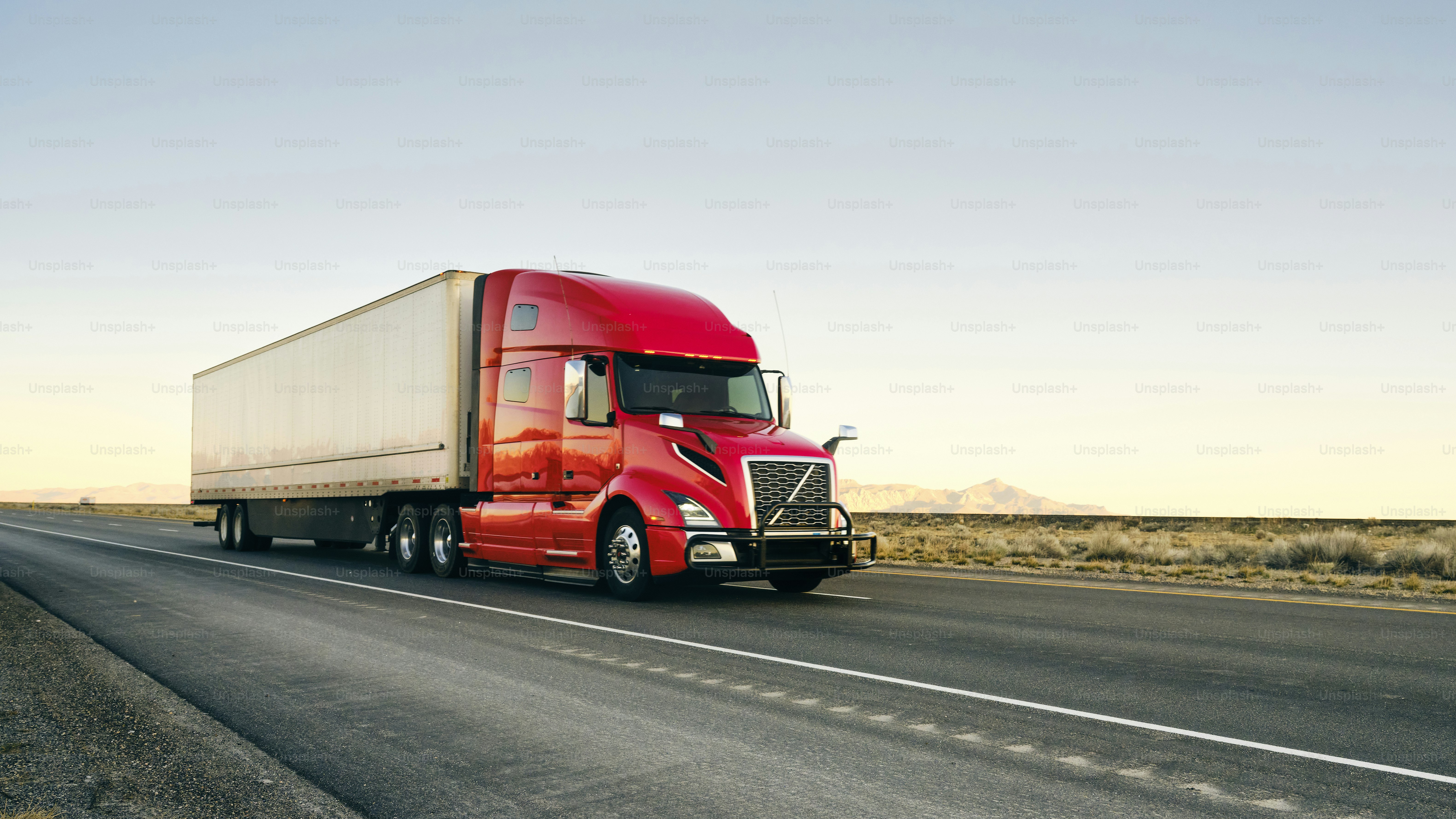 Large semi truck hauling freight on the open highway in the western USA ...