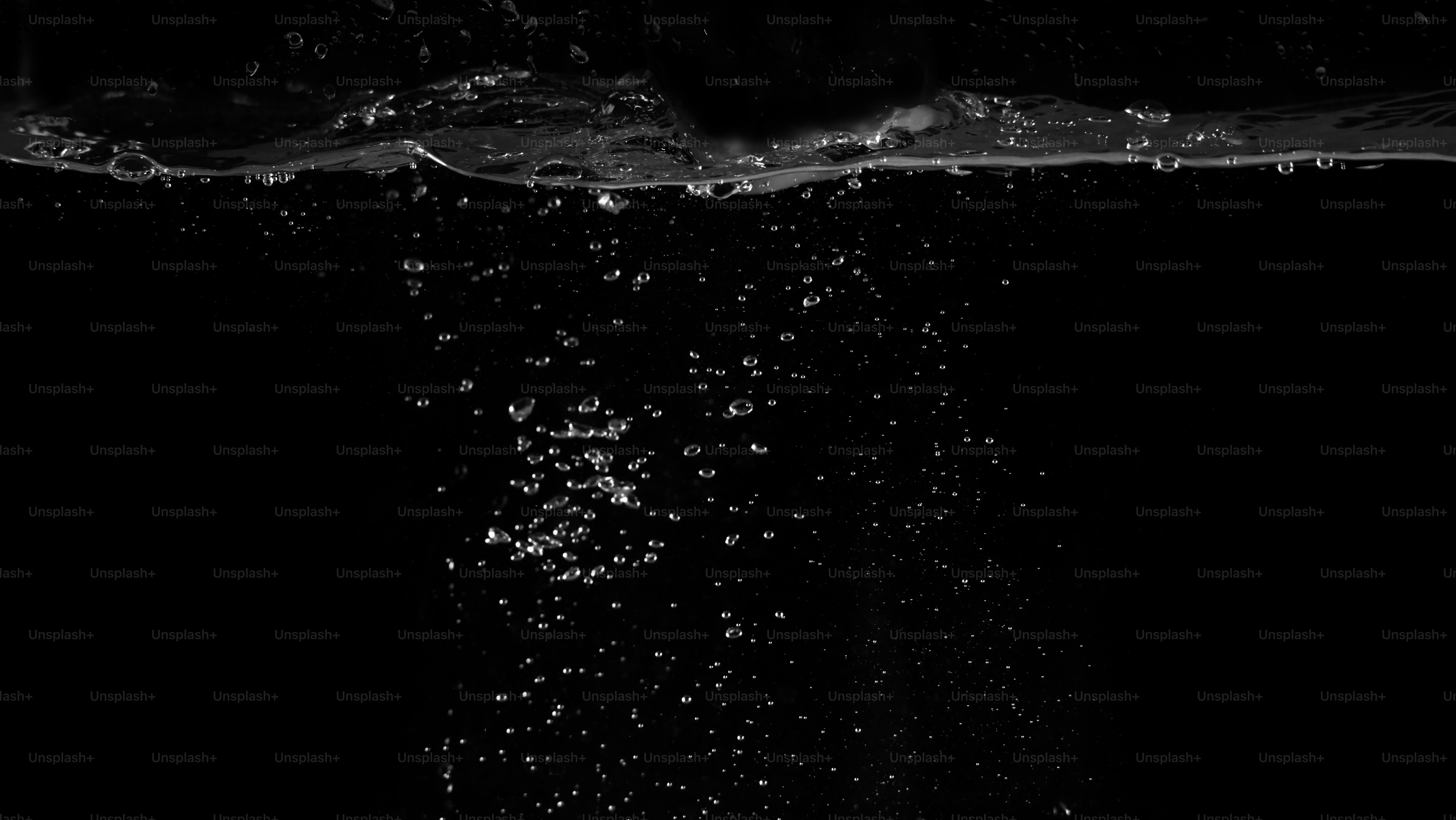Water bubbles floating on black background which represent refreshing ...