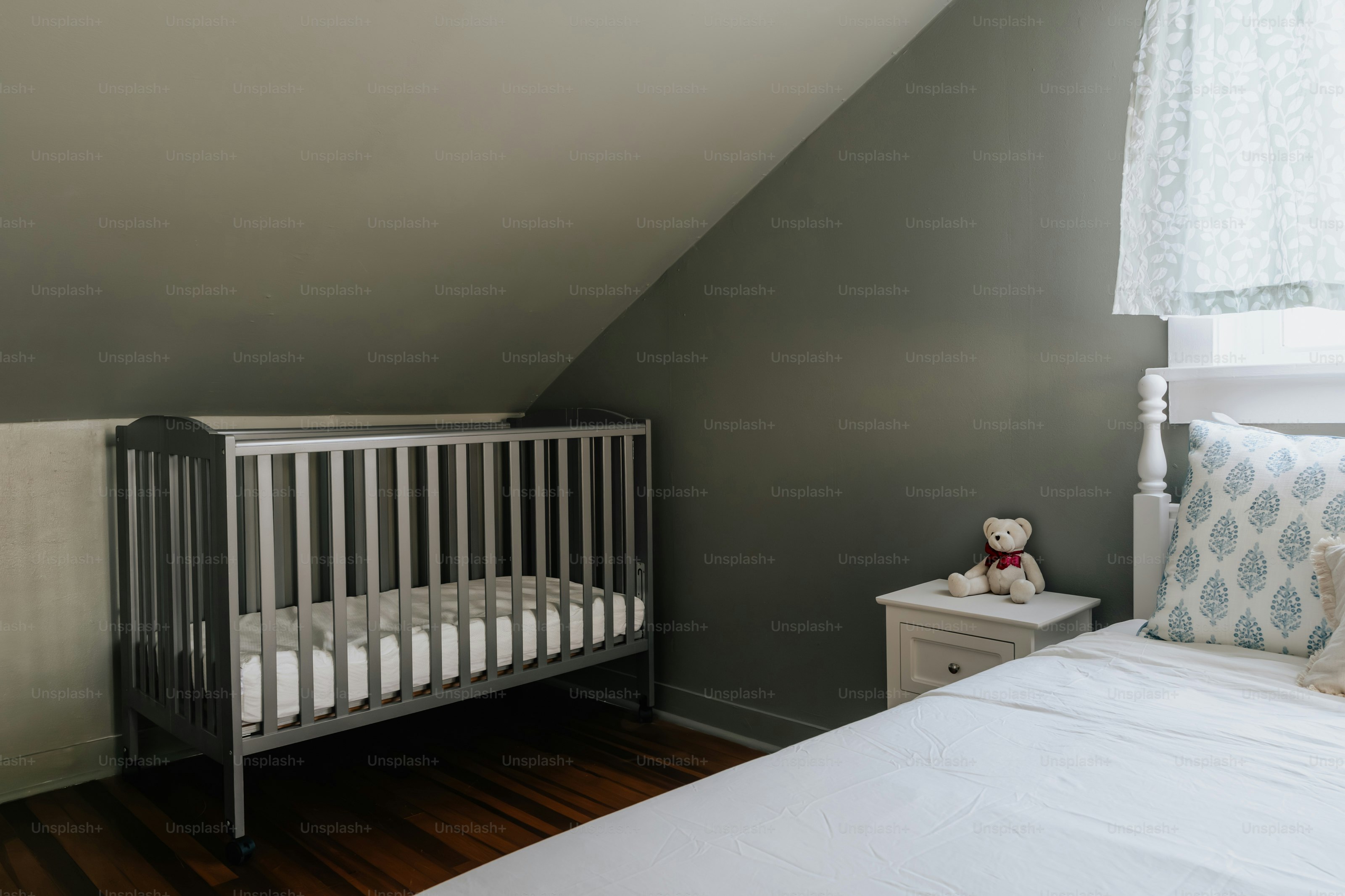 A baby crib in a bedroom with a window photo – Green Image on Unsplash
