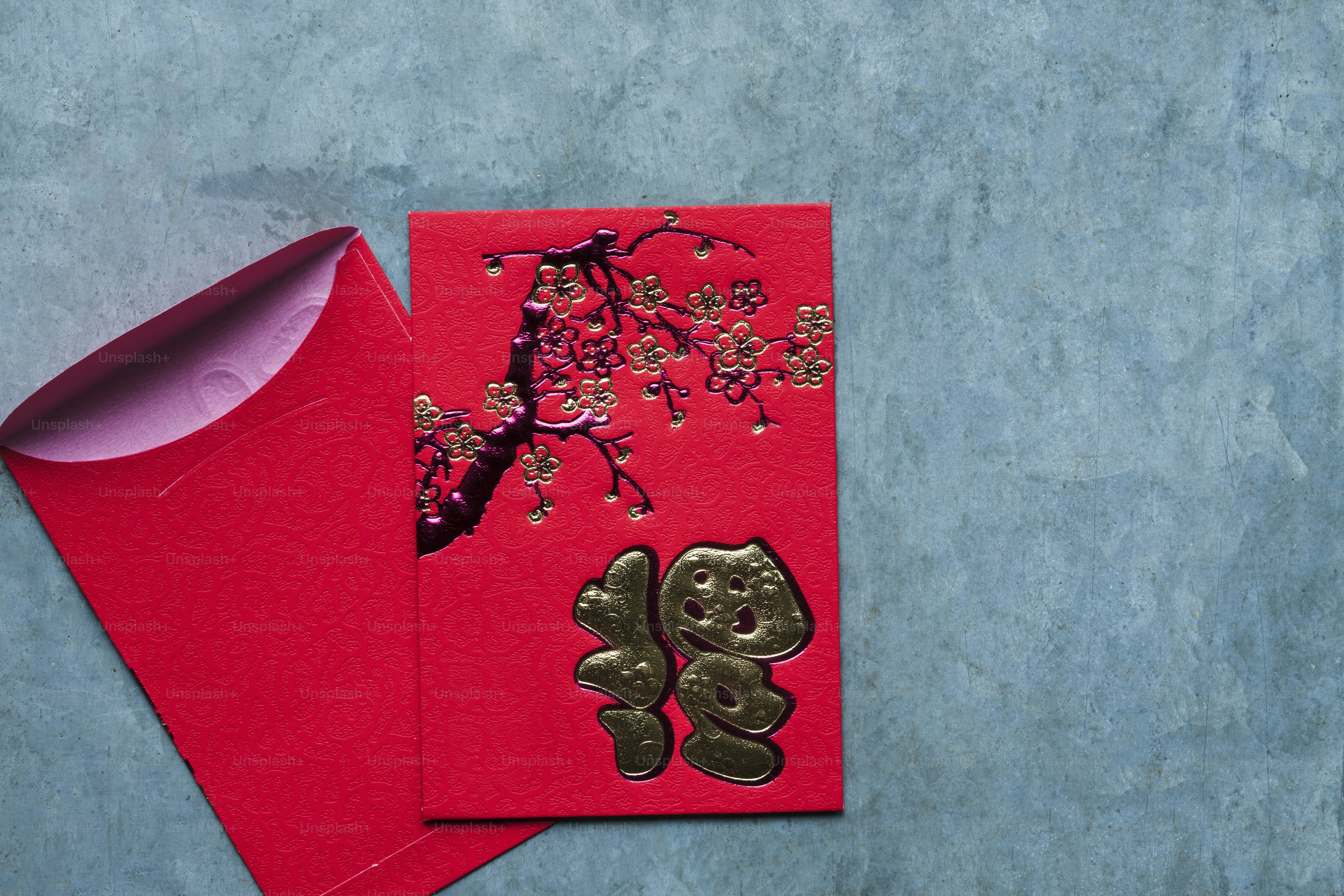 A pair of red envelopes with gold foil designs photo – Red envelope ...