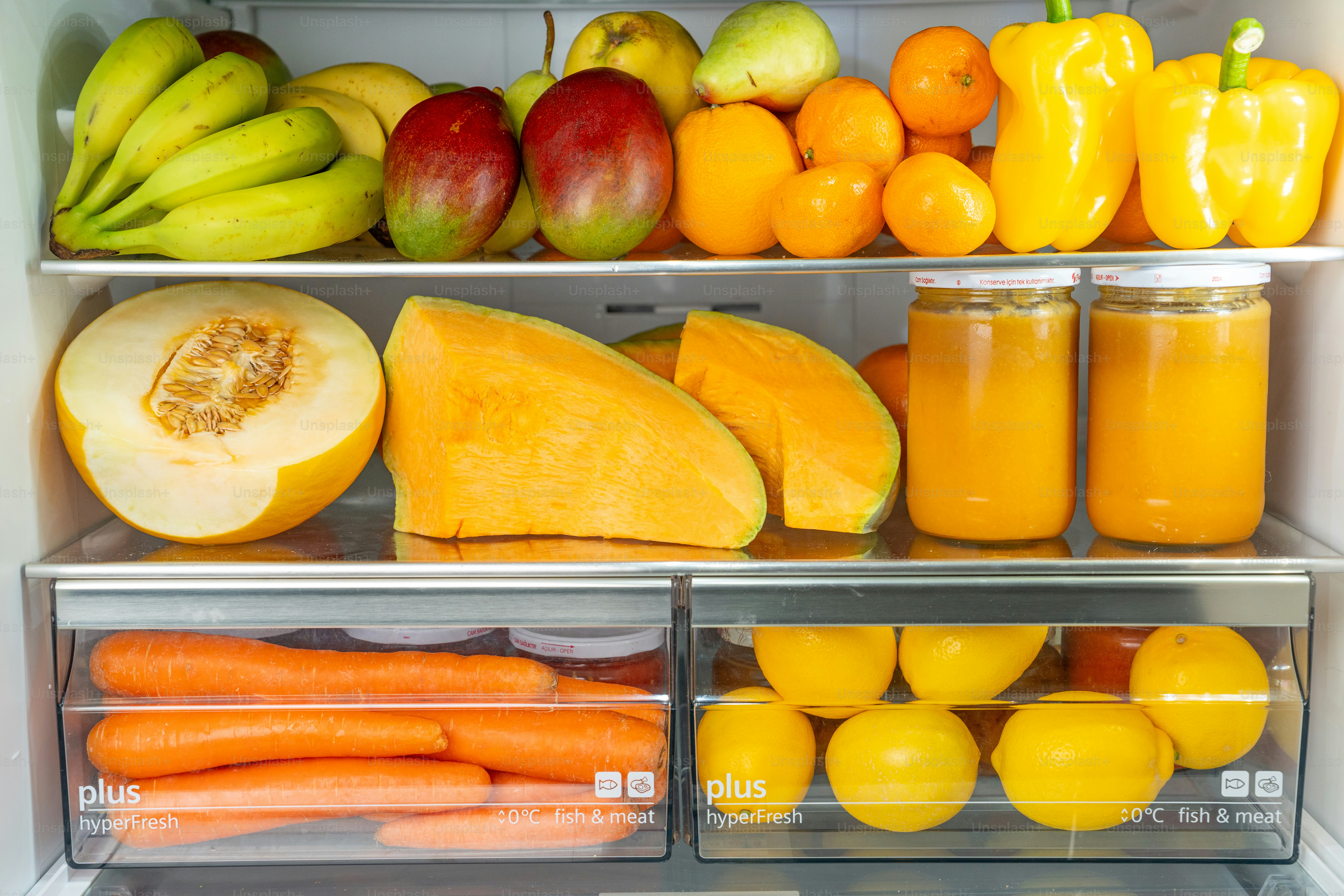 A refrigerator filled with lots of different types of fruits and ...