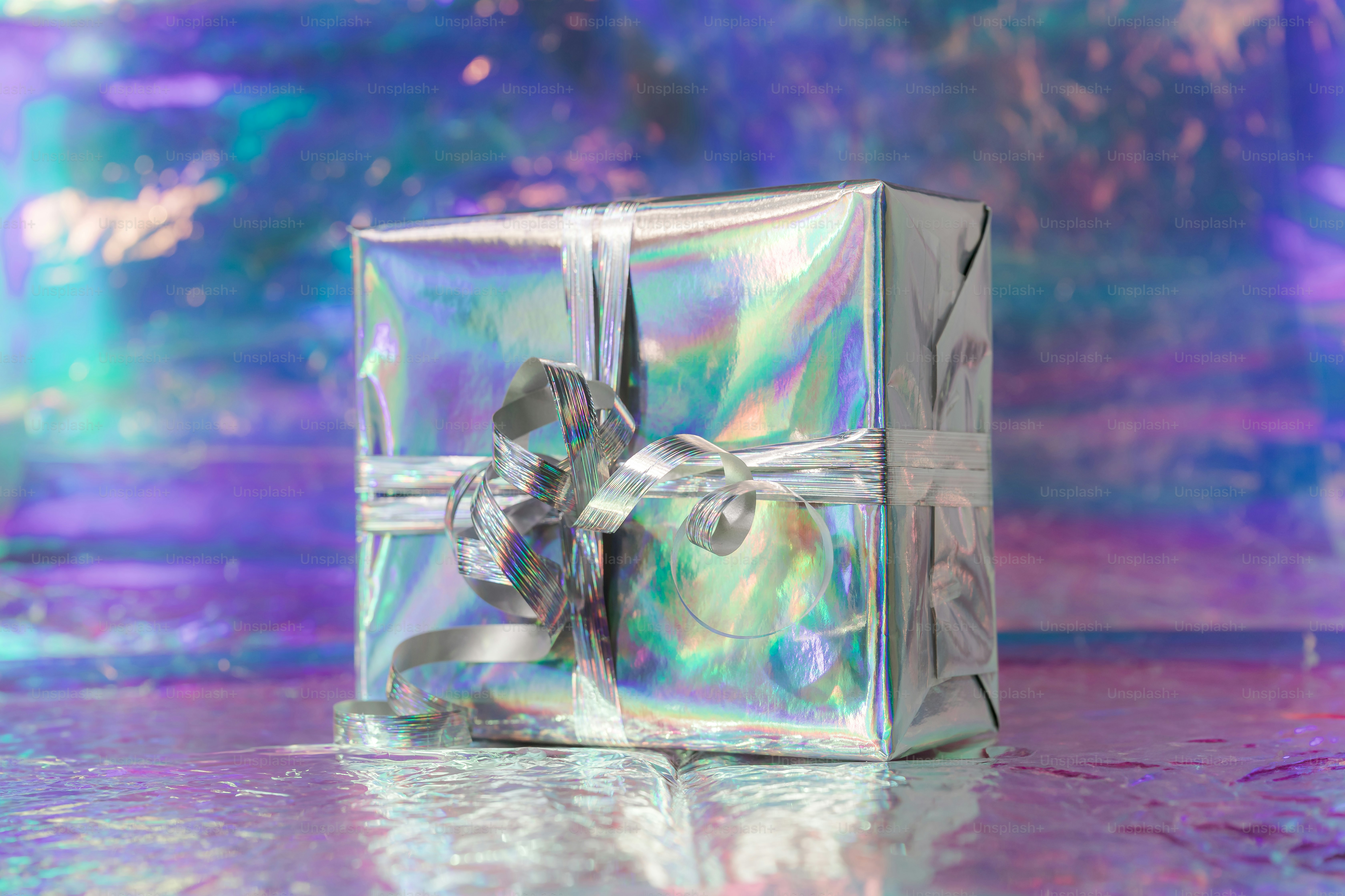 A shiny present box sitting on a shiny surface photo – Gift box Image ...