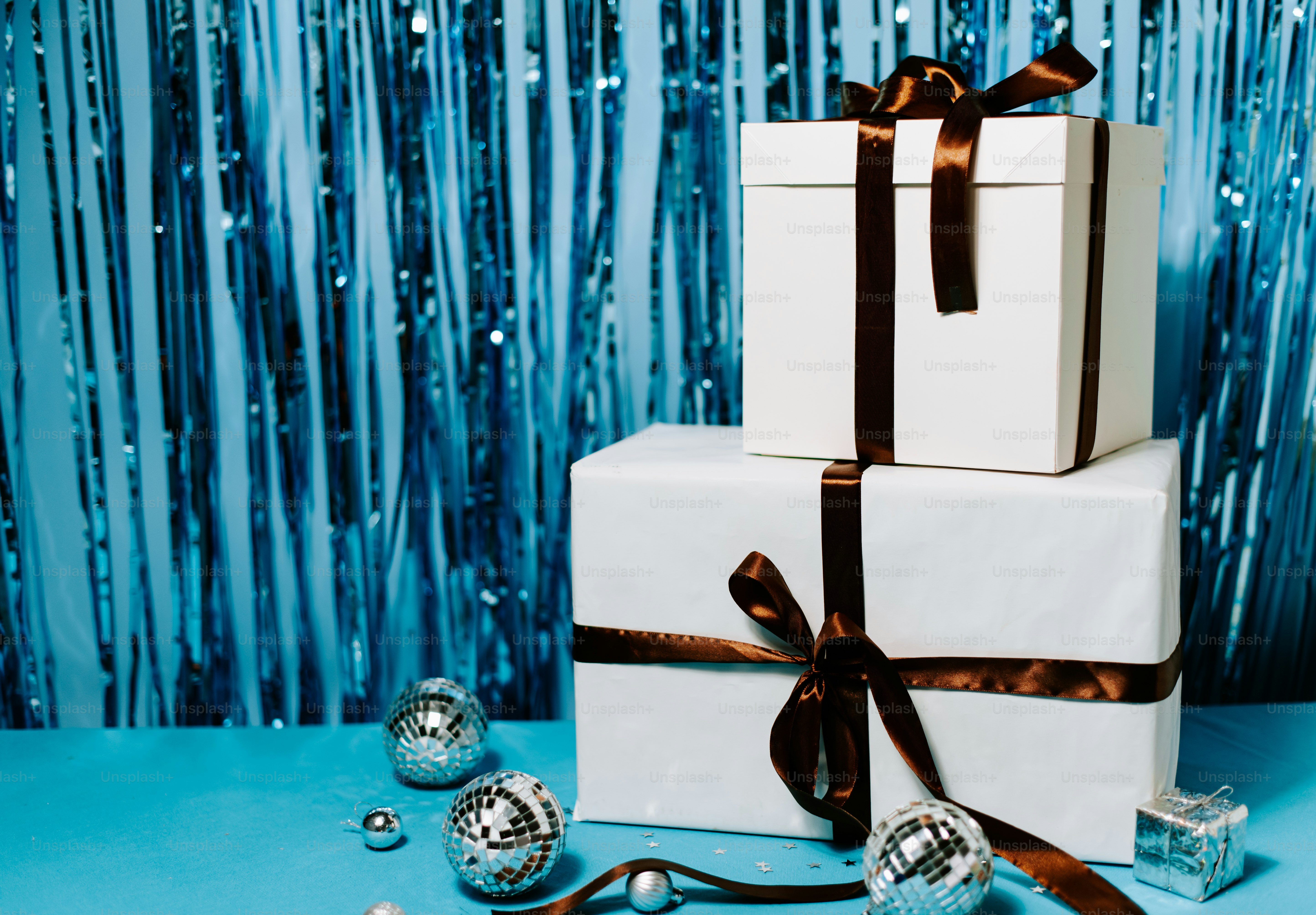 A stack of presents sitting on top of a table photo – Modern aesthetic ...