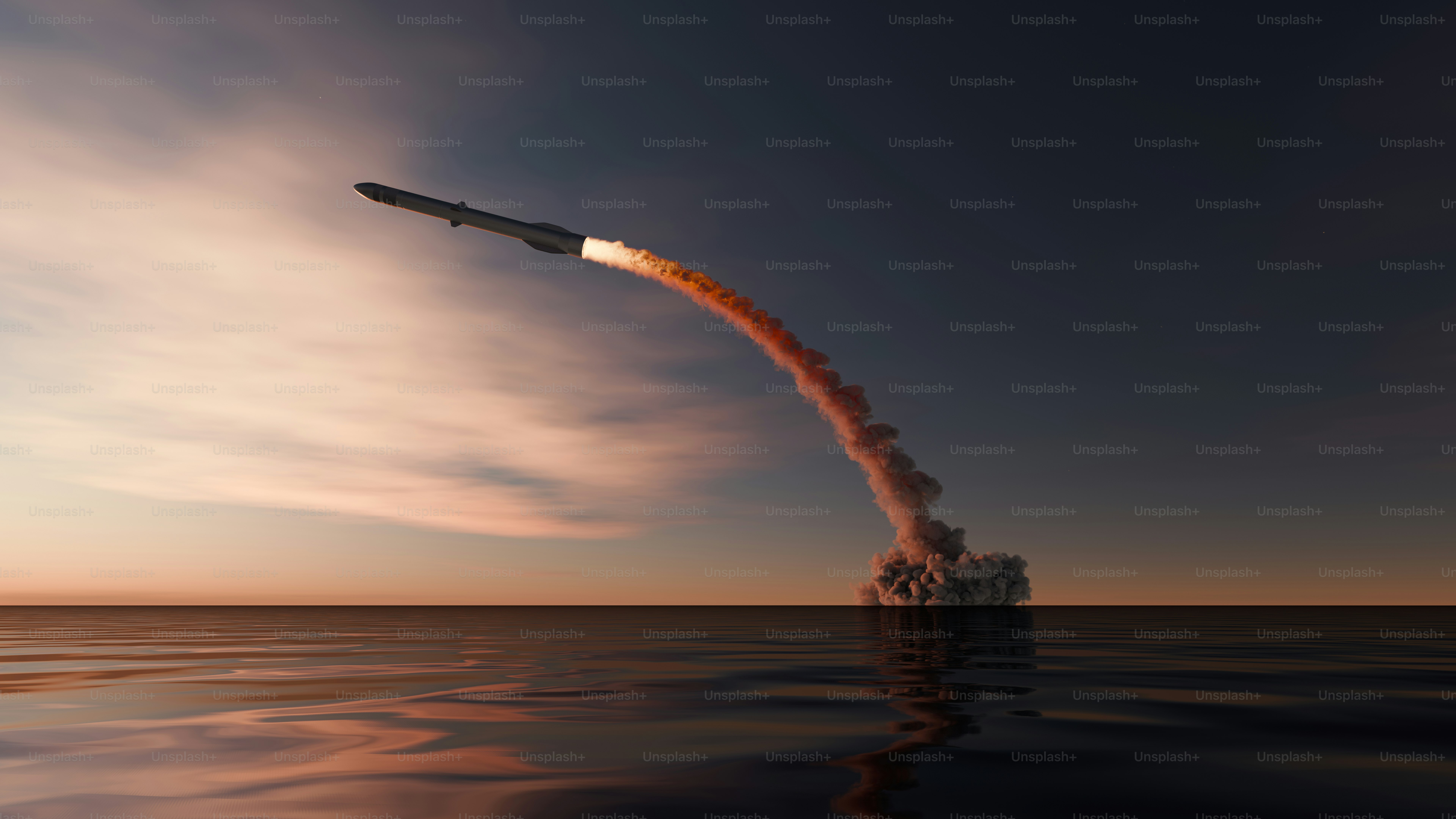 A missile launching into the air over a body of water photo – Rocket ...