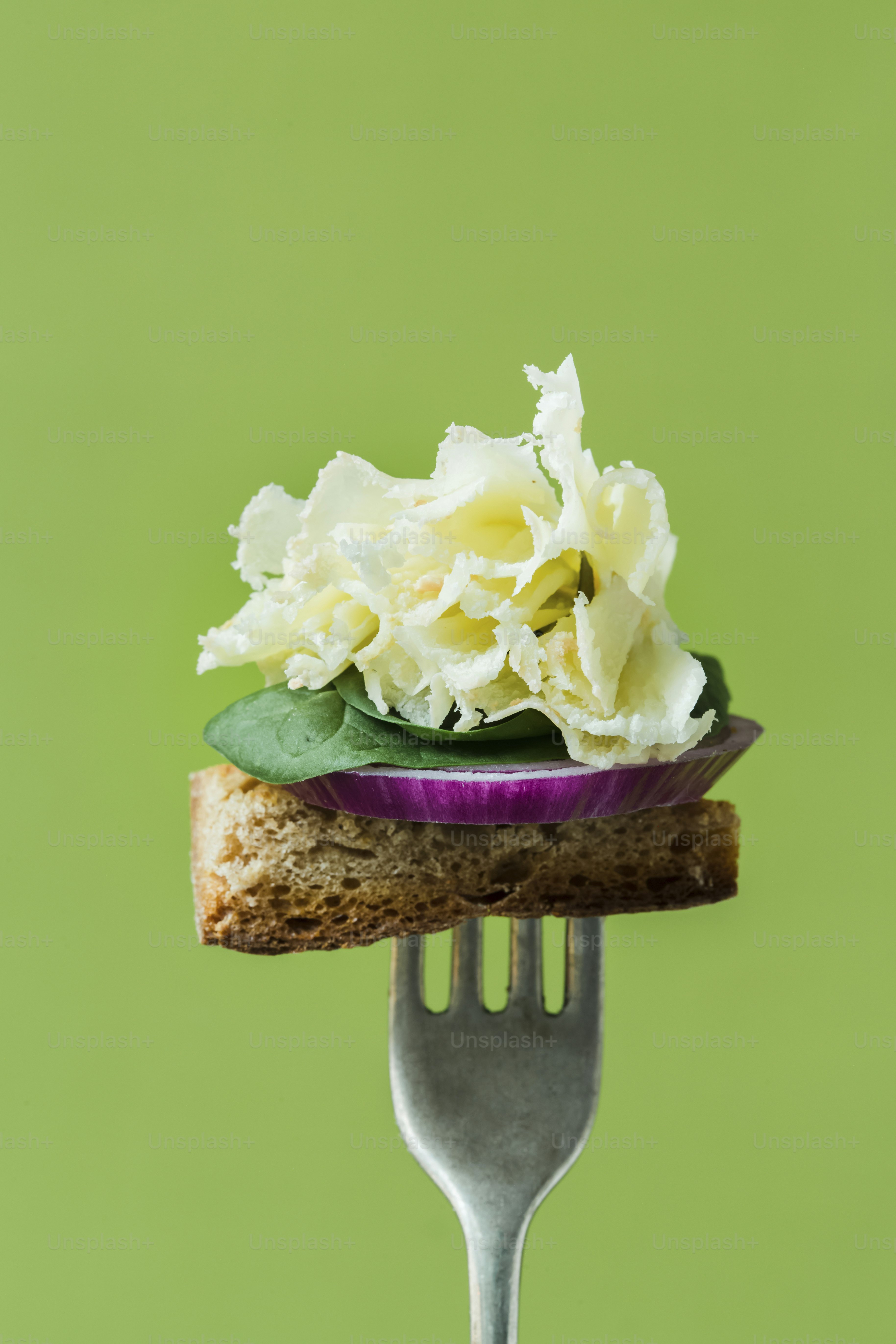A piece of bread with flowers on top of it photo – Food styling Image ...