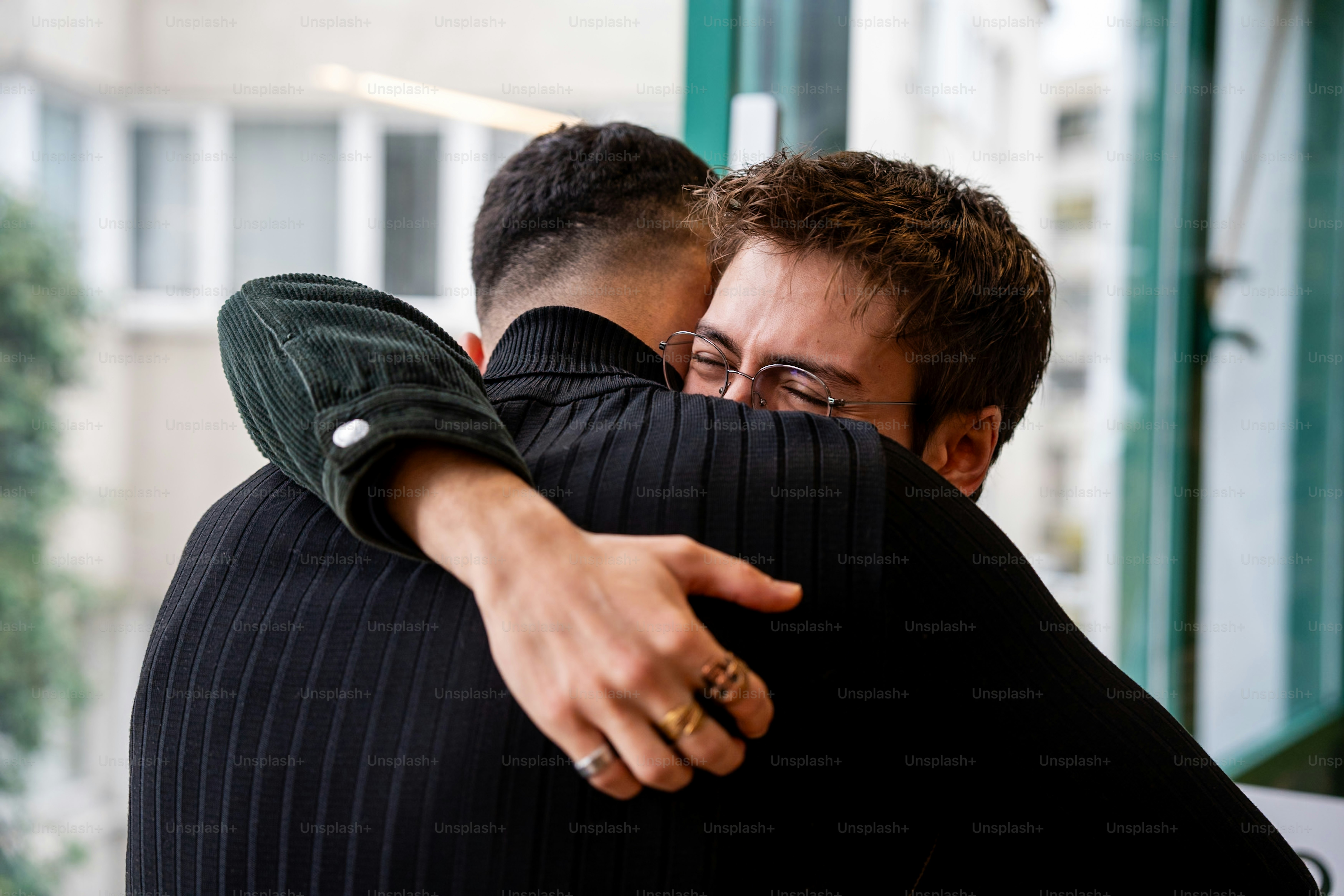 Two men hugging each other on a city street photo – Mens mental health ...