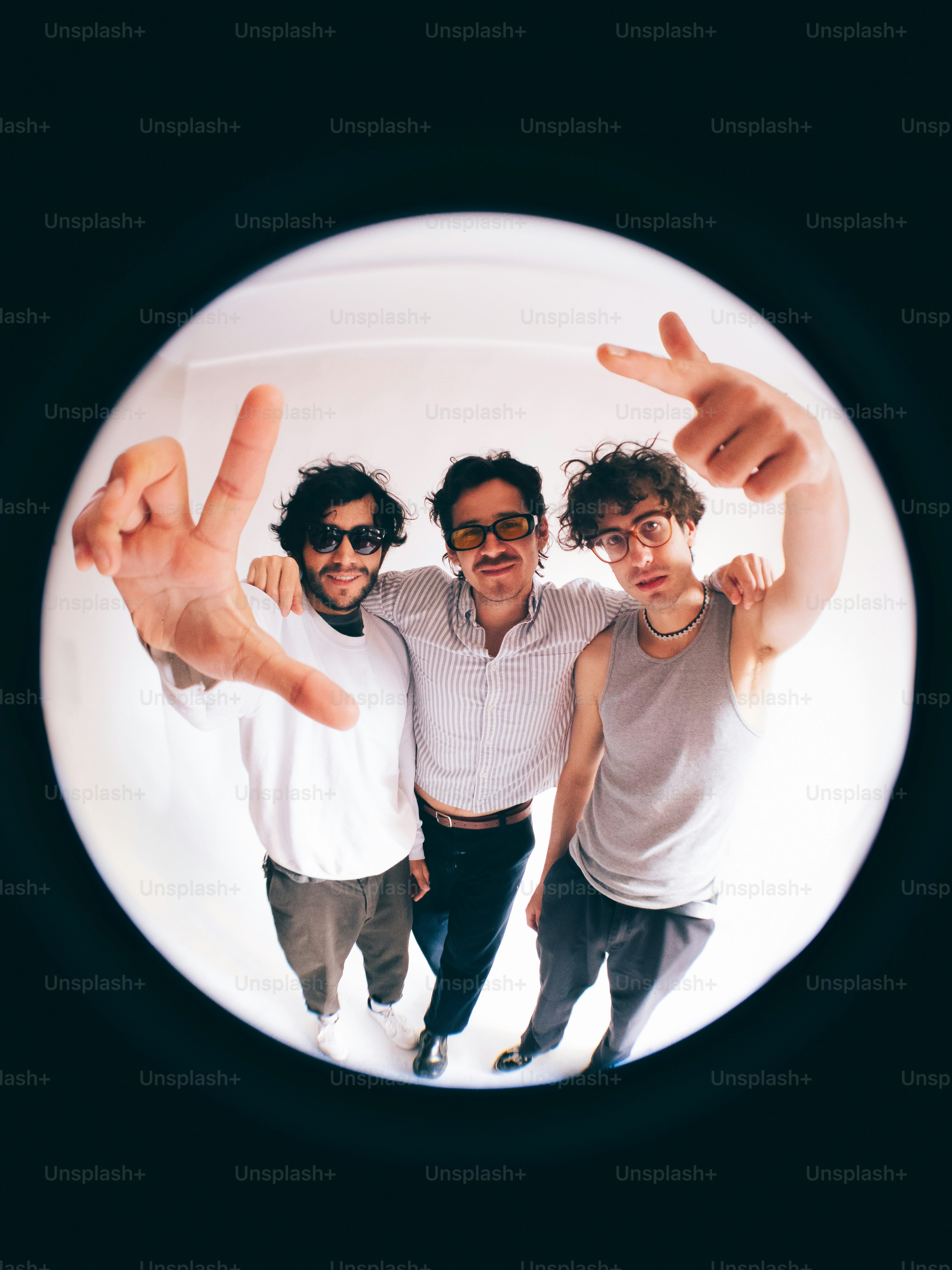 A group of three men standing next to each other photo – Trend Image on ...