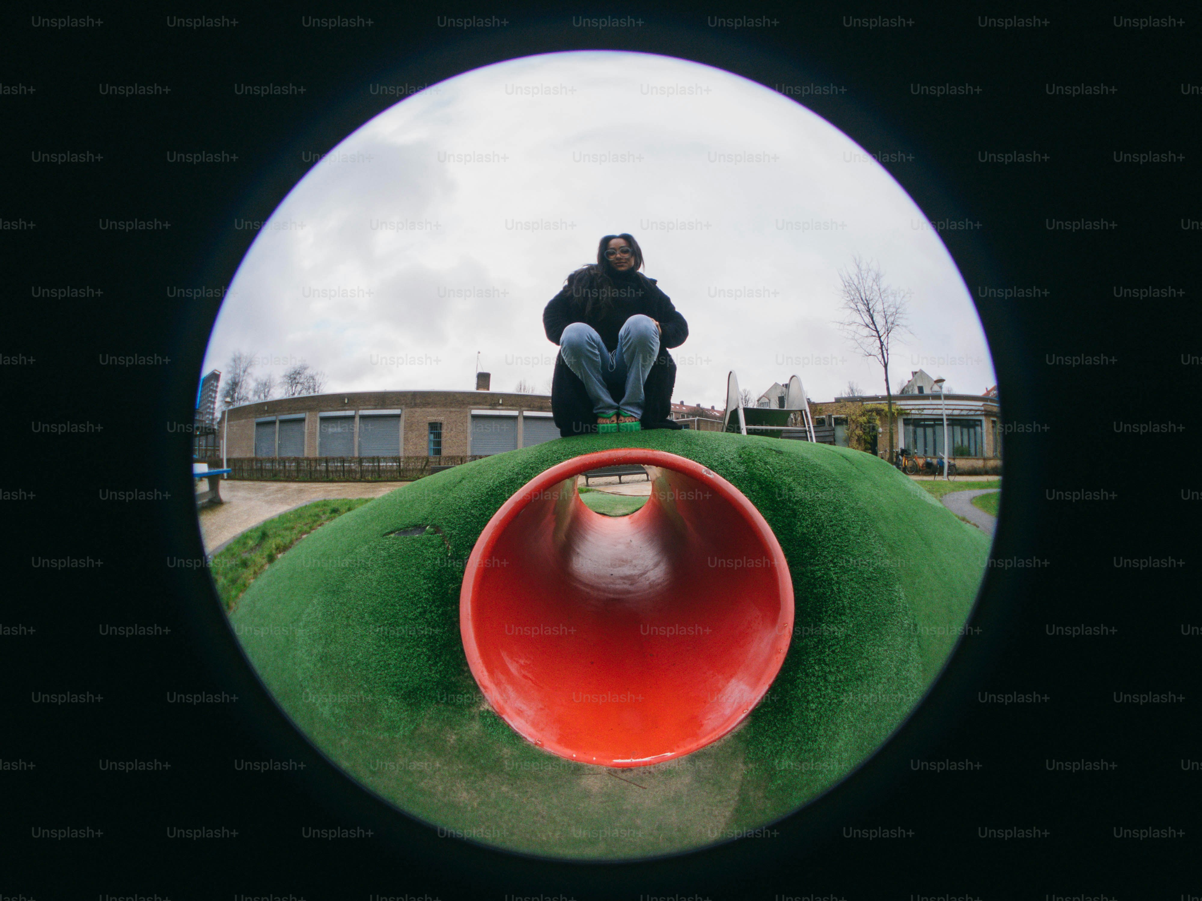 A man sitting on top of a green slide photo – Girl Image on Unsplash