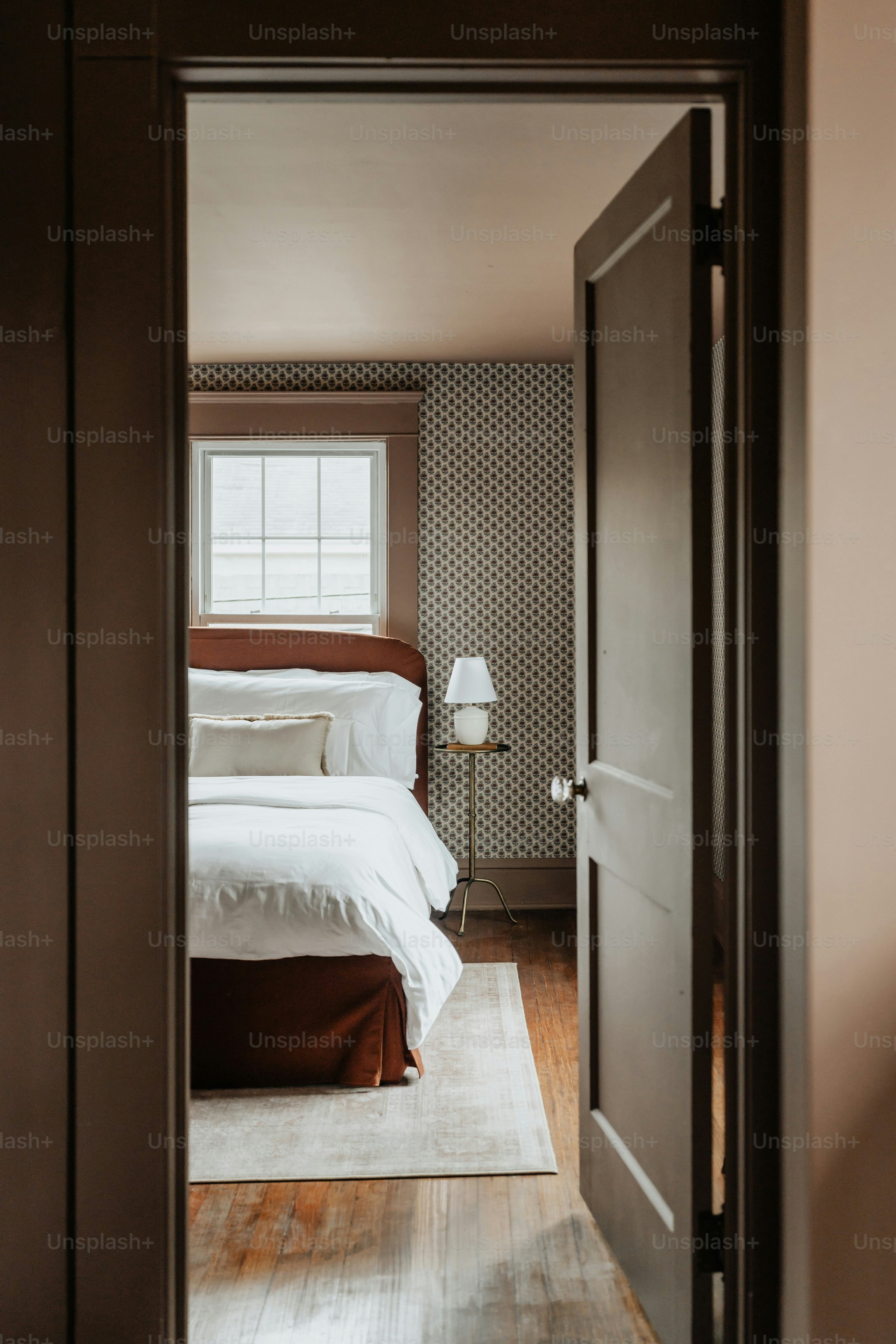 A bed sitting inside of a bedroom next to a doorway photo – Building ...