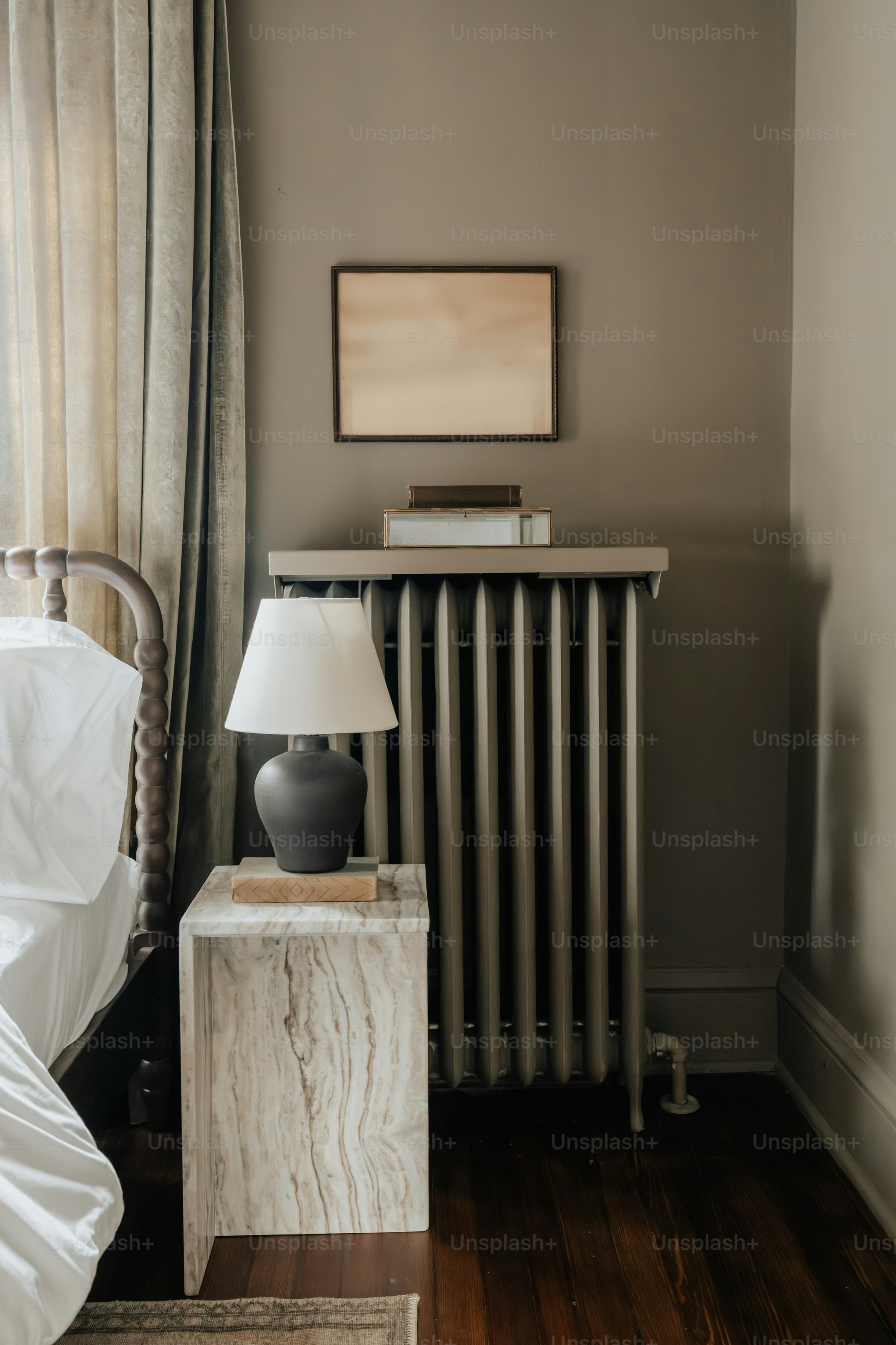 A bedroom with a radiator and a bed photo – Night stand Image on Unsplash