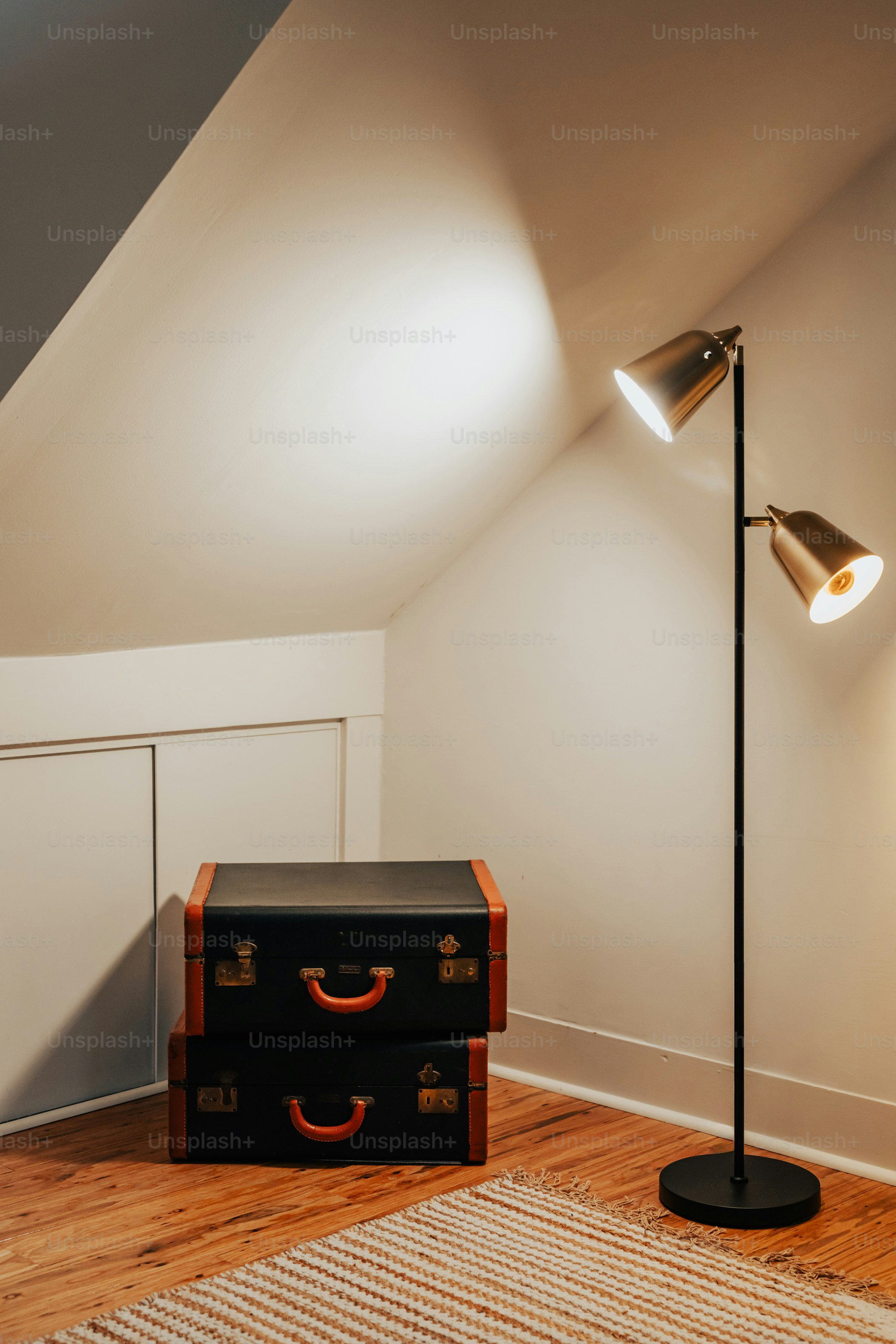 A suitcase sitting on the floor next to a lamp photo – Trunks Image on ...