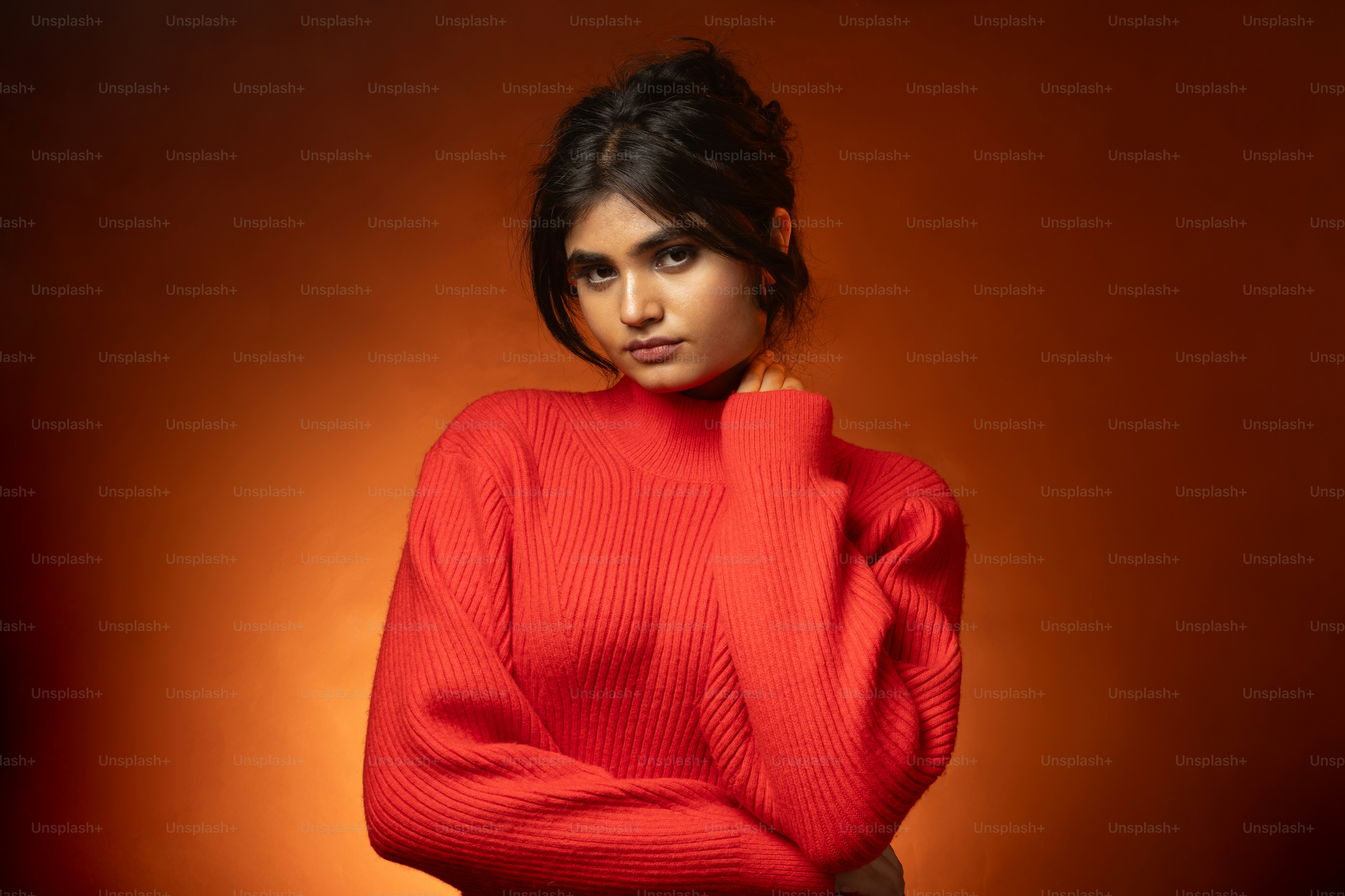 A woman in a red sweater posing for a picture photo – Gradient ...