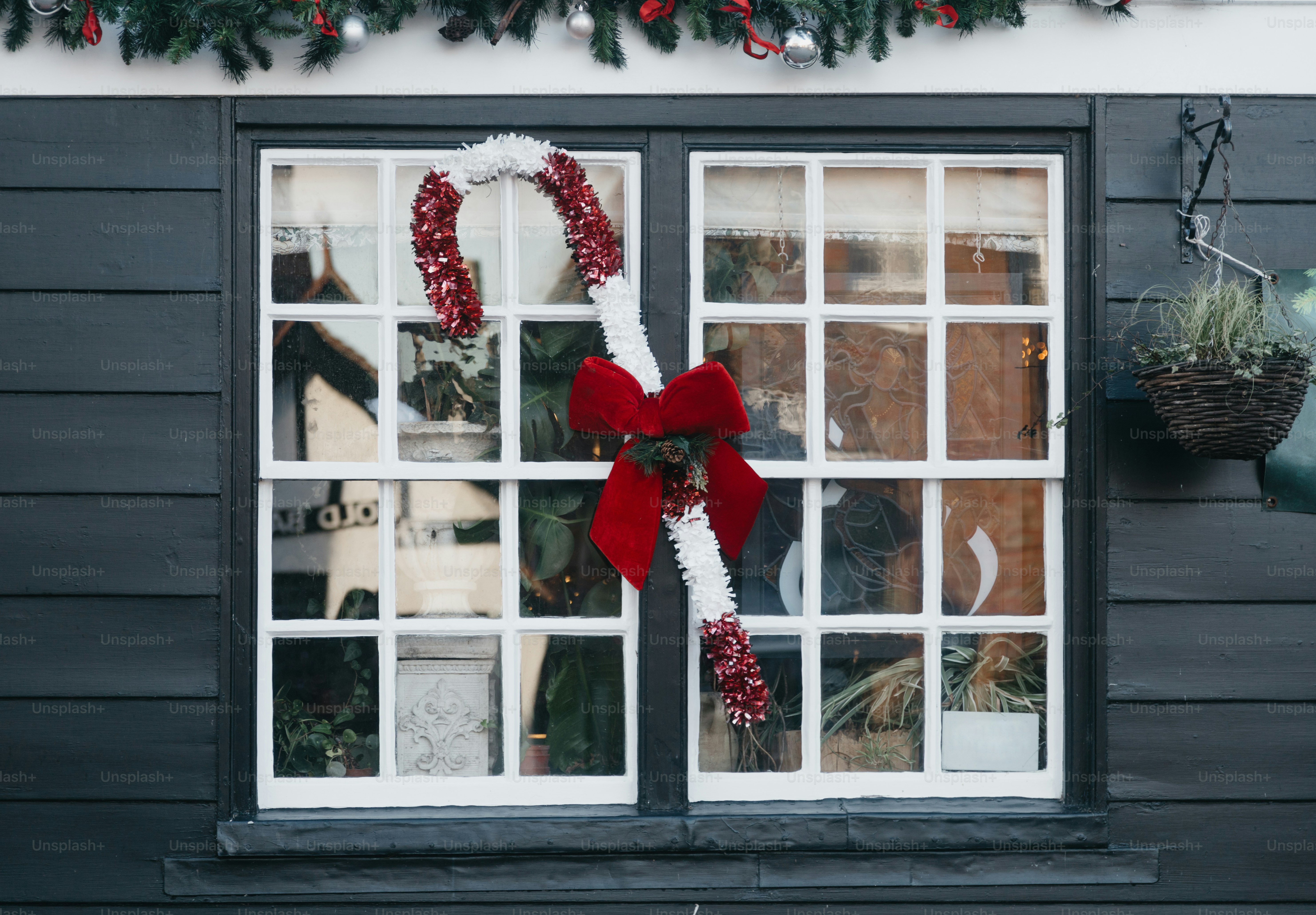A window decorated with a red bow and a candy cane photo – Christmas ...