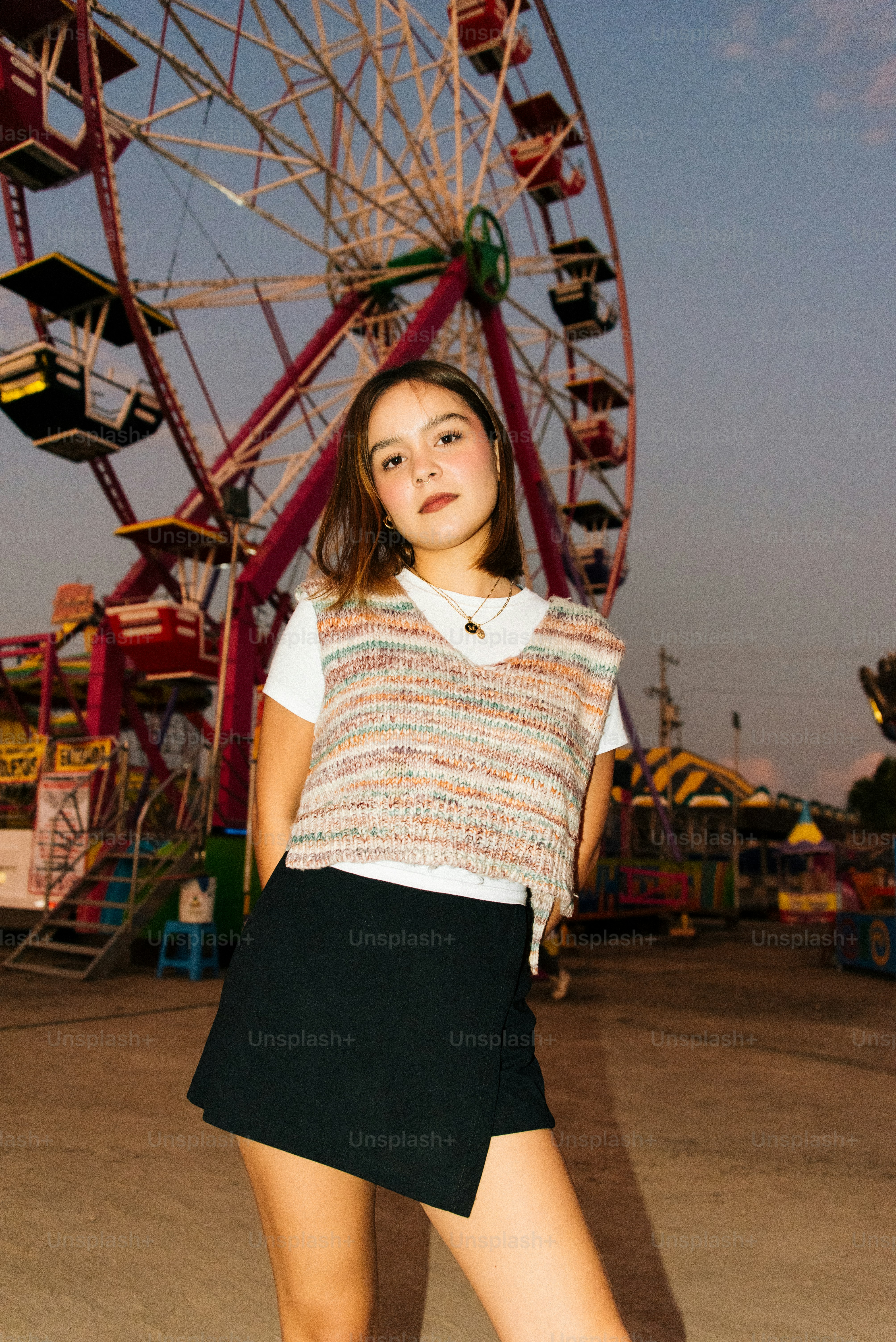 A woman standing in front of a ferris wheel photo – Portrait Image on ...