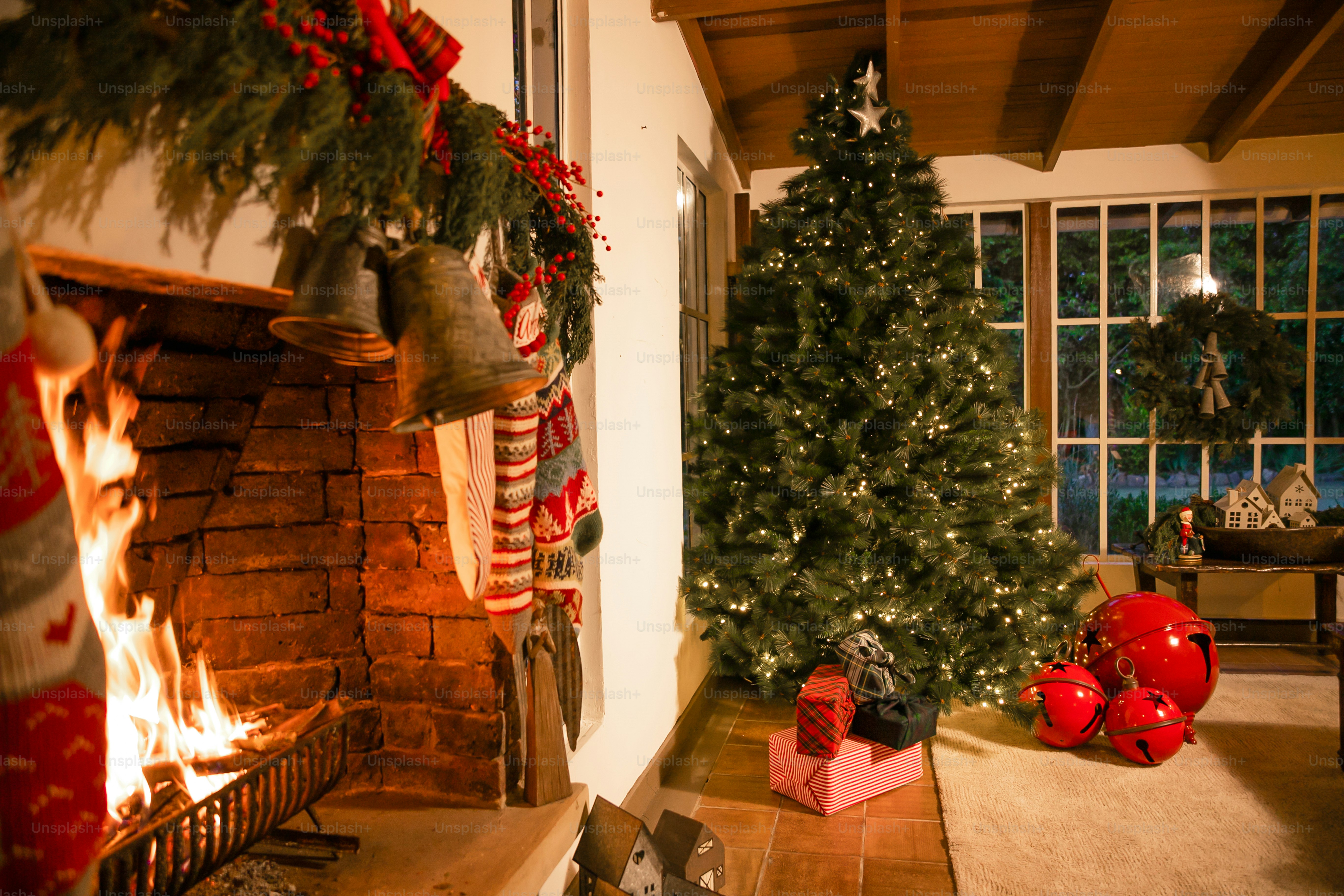 A living room with a christmas tree and a fire place photo – Log fire ...