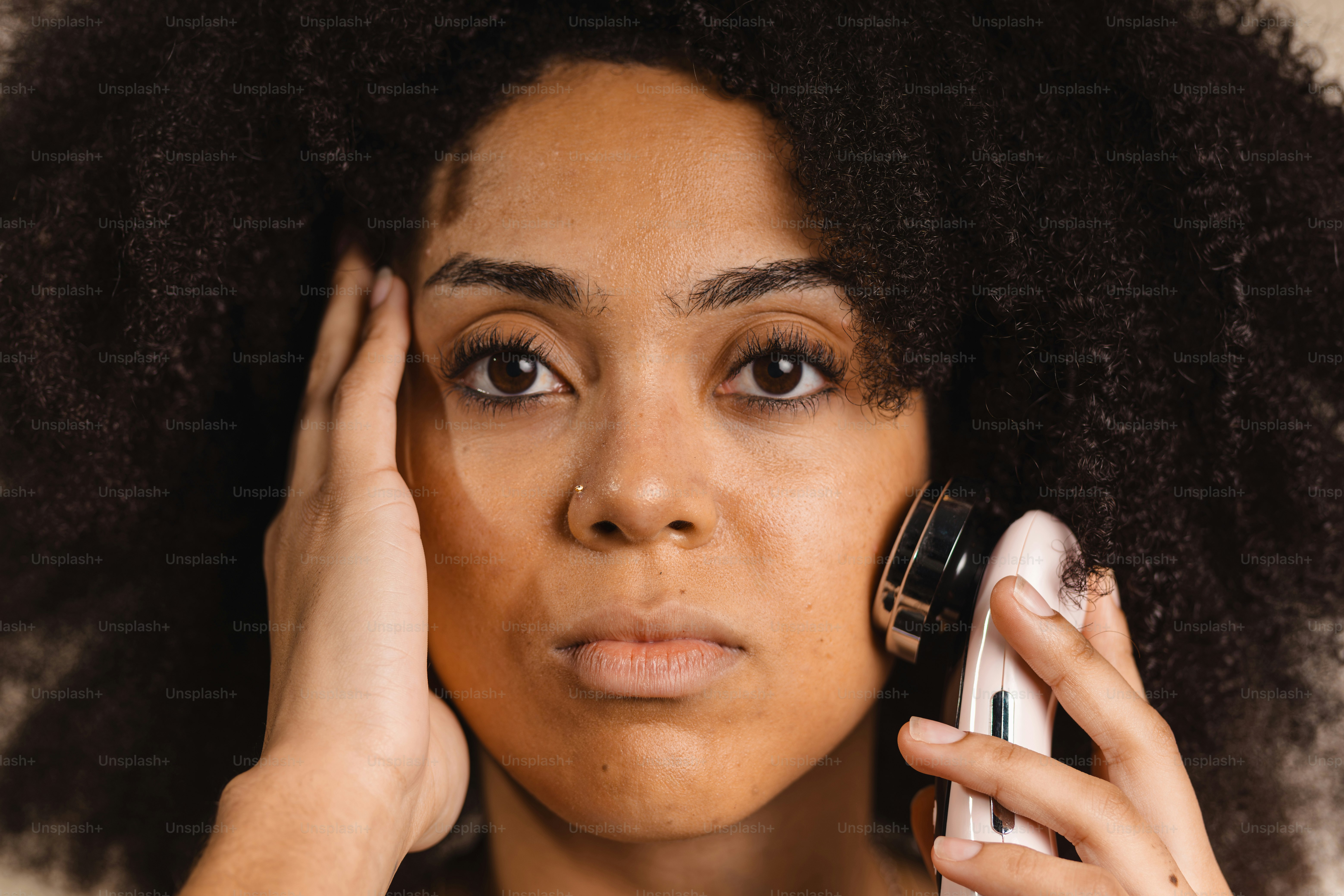 A woman holding a cell phone to her ear photo – Beauty Image on Unsplash