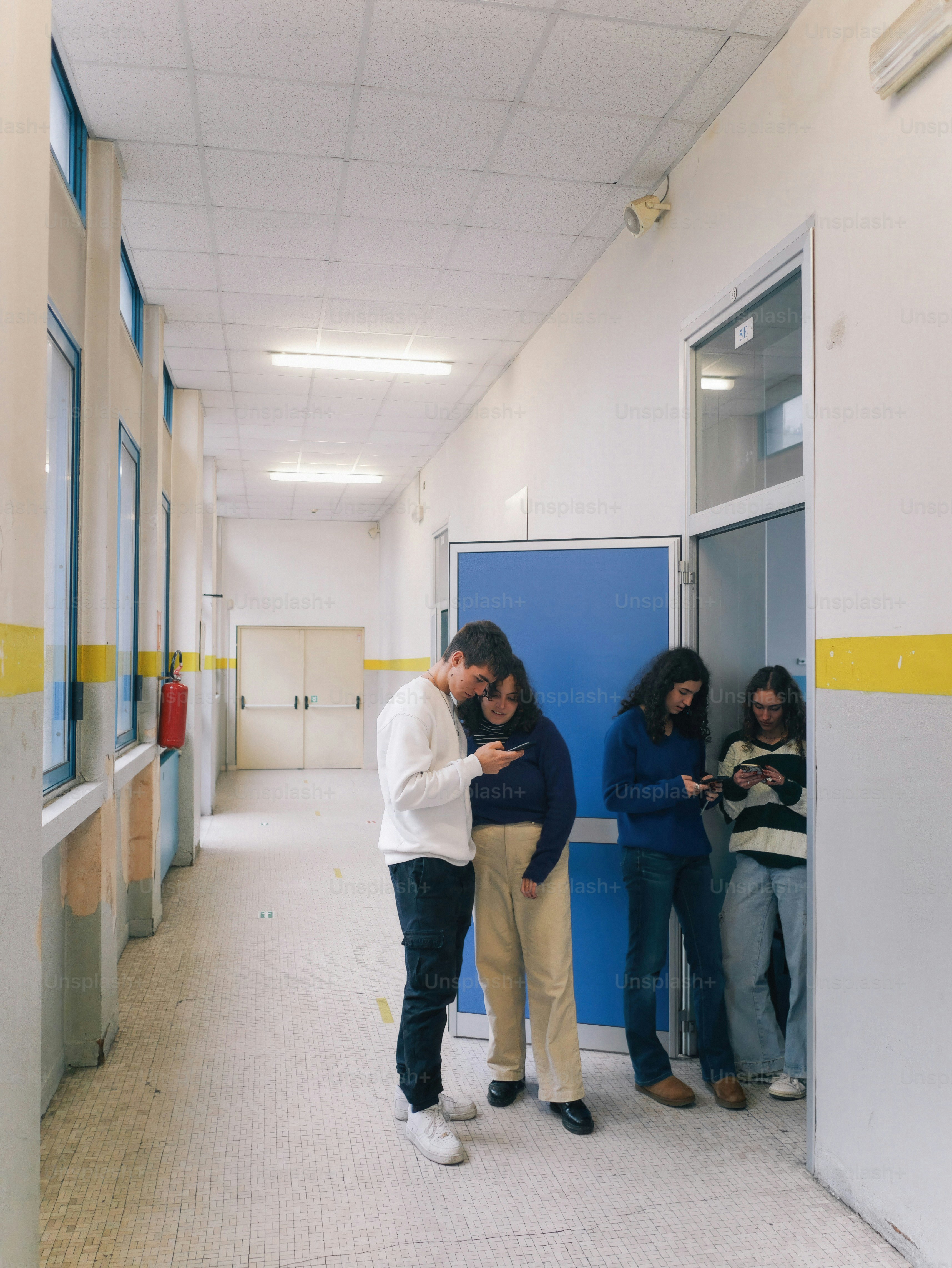 A group of people standing in a hallway photo – School Image on Unsplash