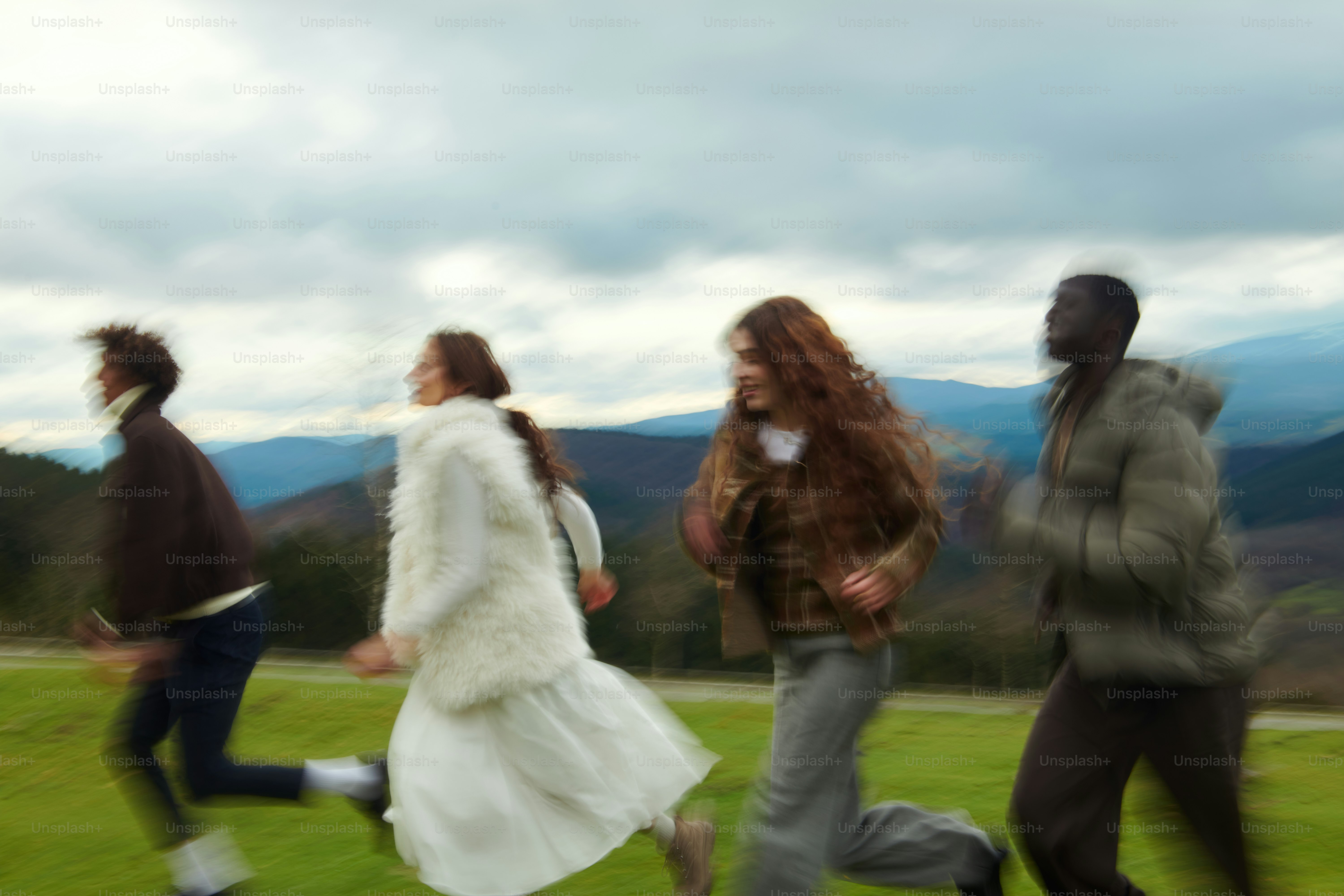 A group of people running in a field photo – Fashion Image on Unsplash