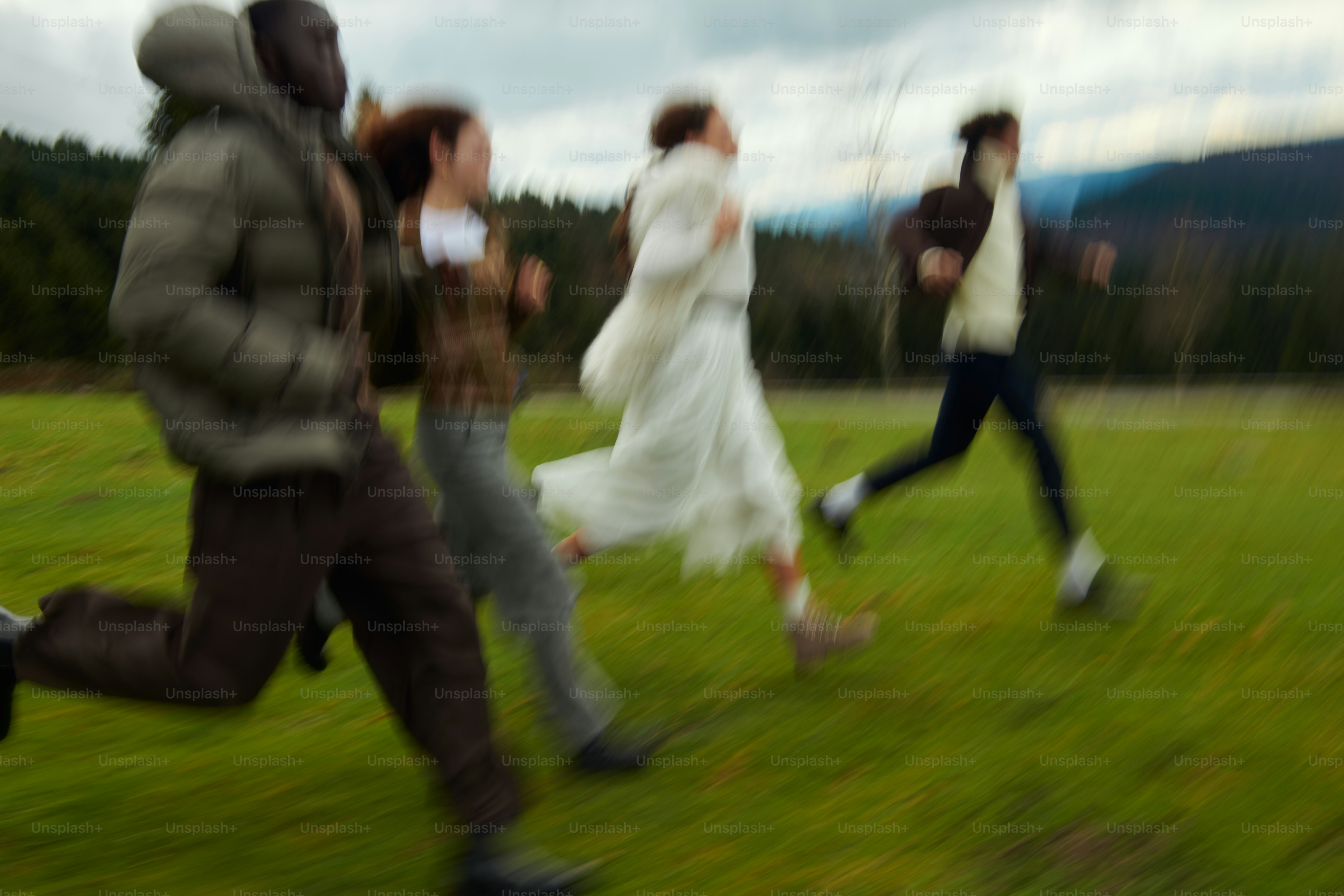 A group of people running in a field photo – Fashion Image on Unsplash