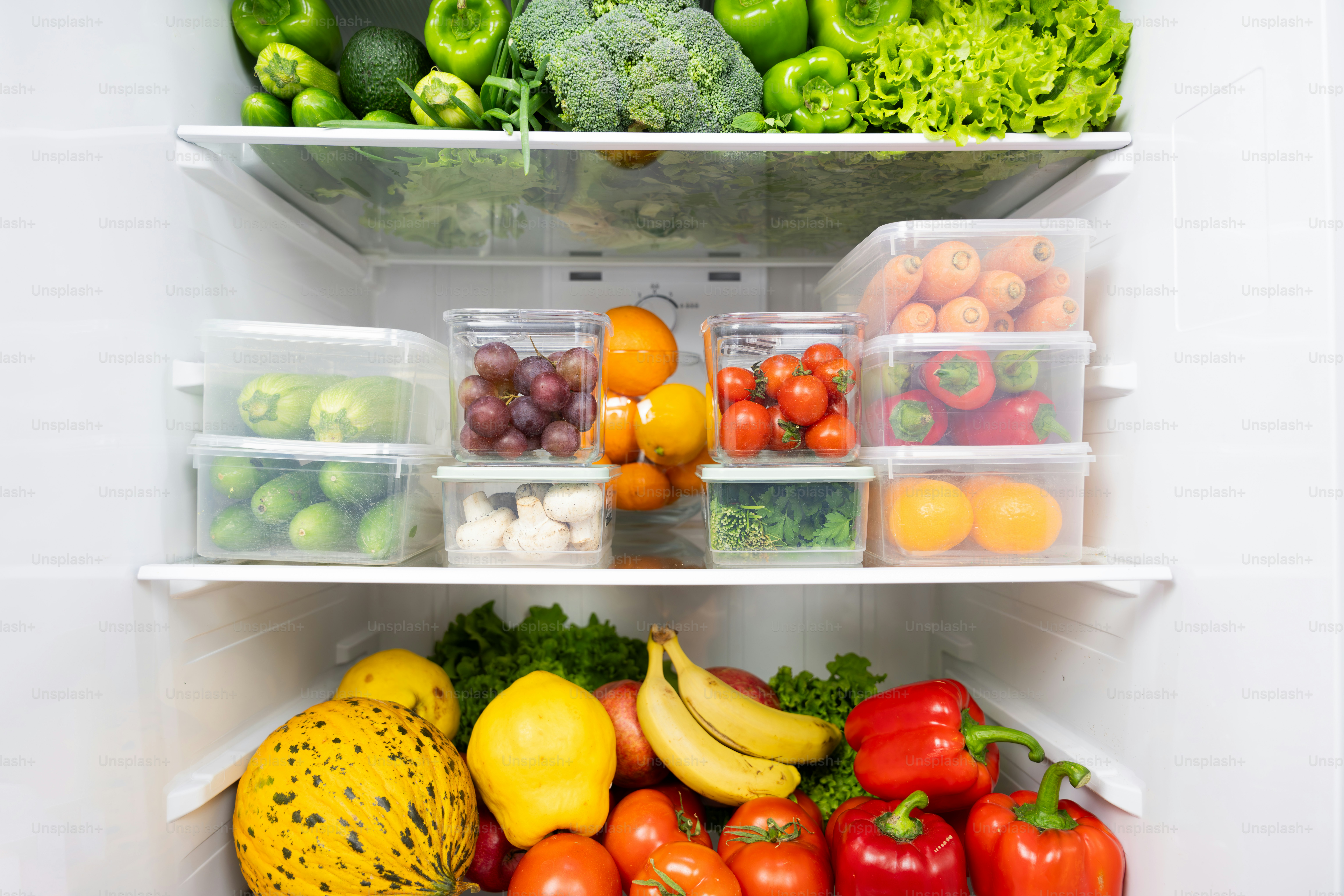 A refrigerator filled with lots of different types of fruits and ...