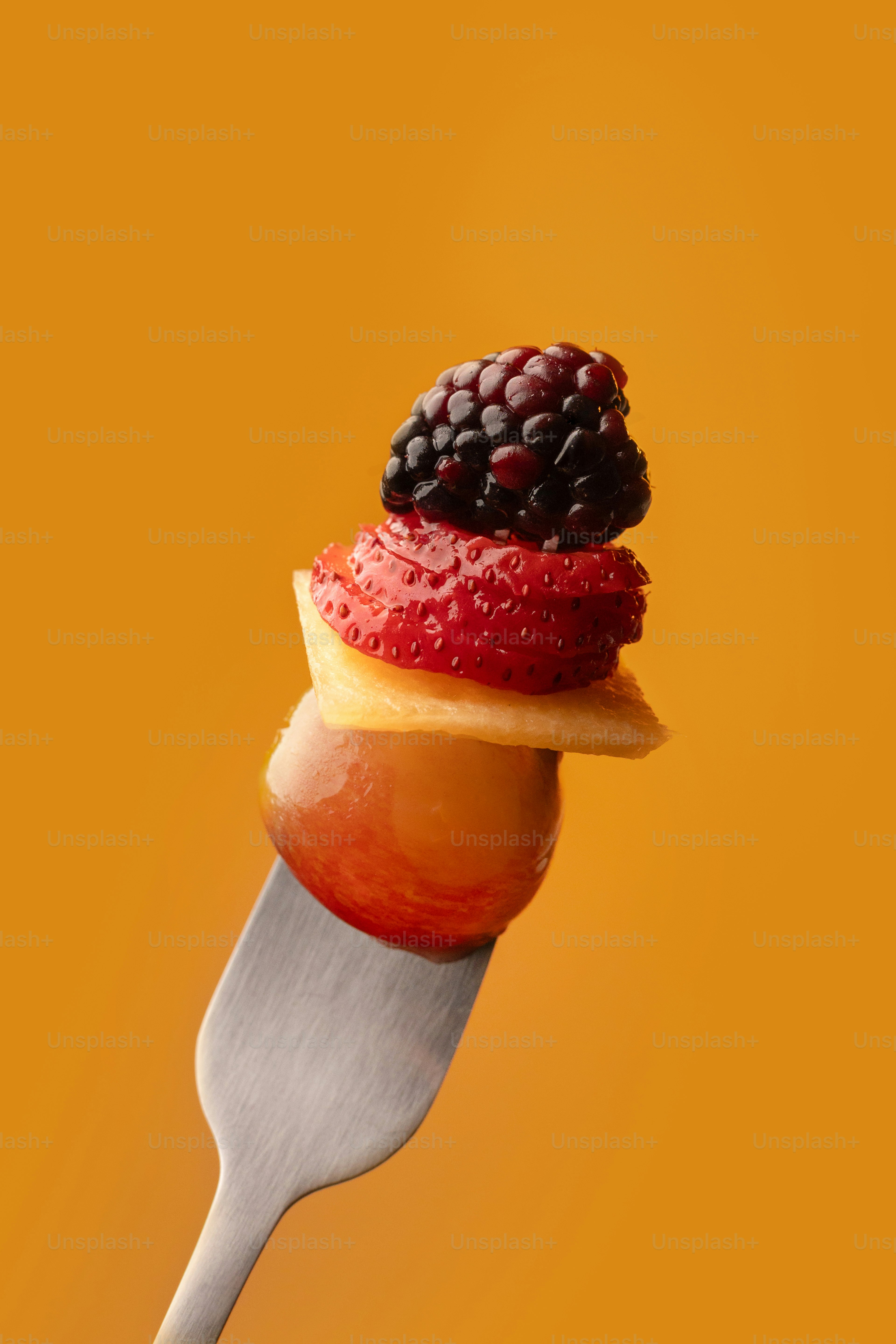 A fork with a fruit on top of it photo – Food styling Image on Unsplash