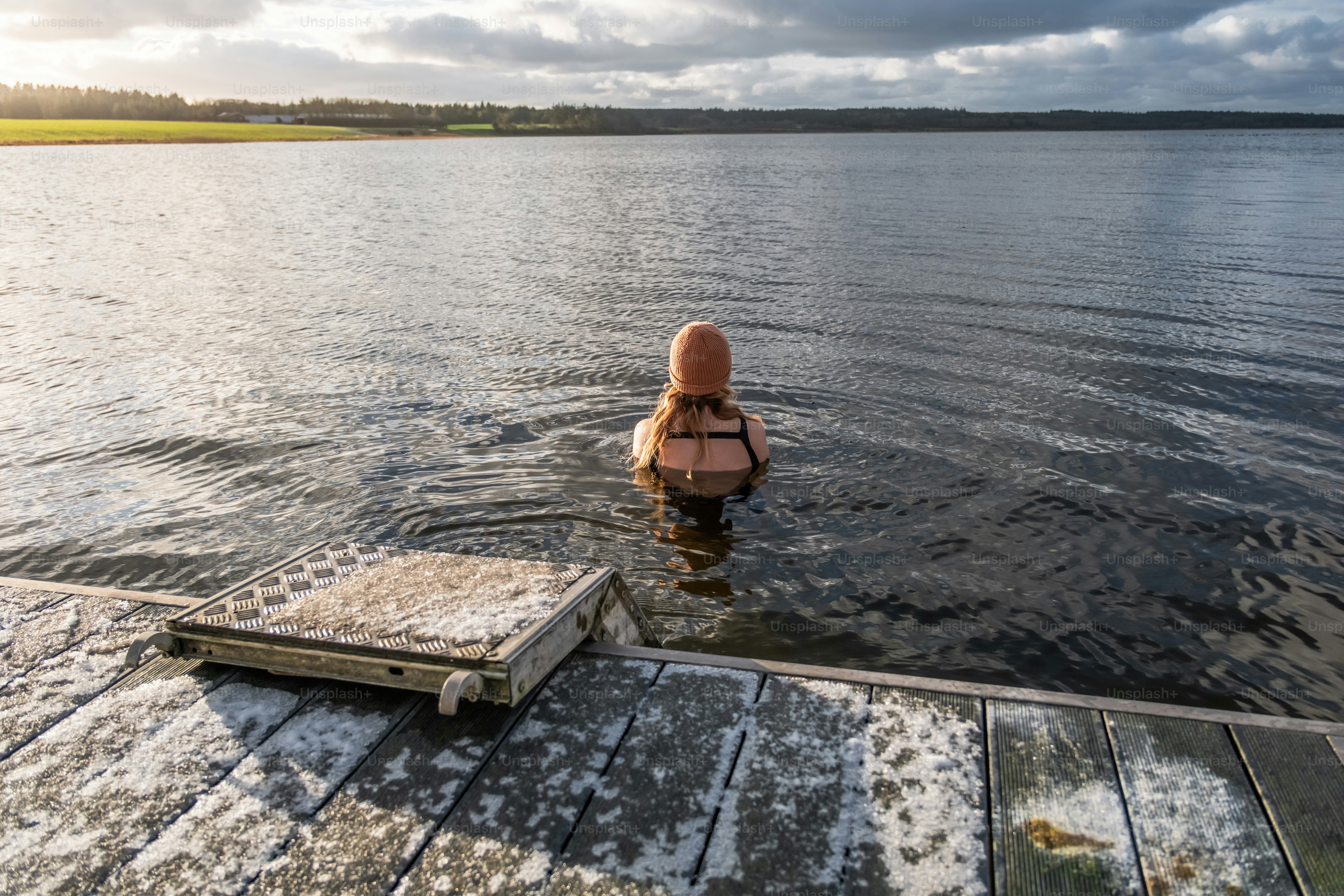 A woman in a bikini standing on a dock photo – Girl Image on Unsplash