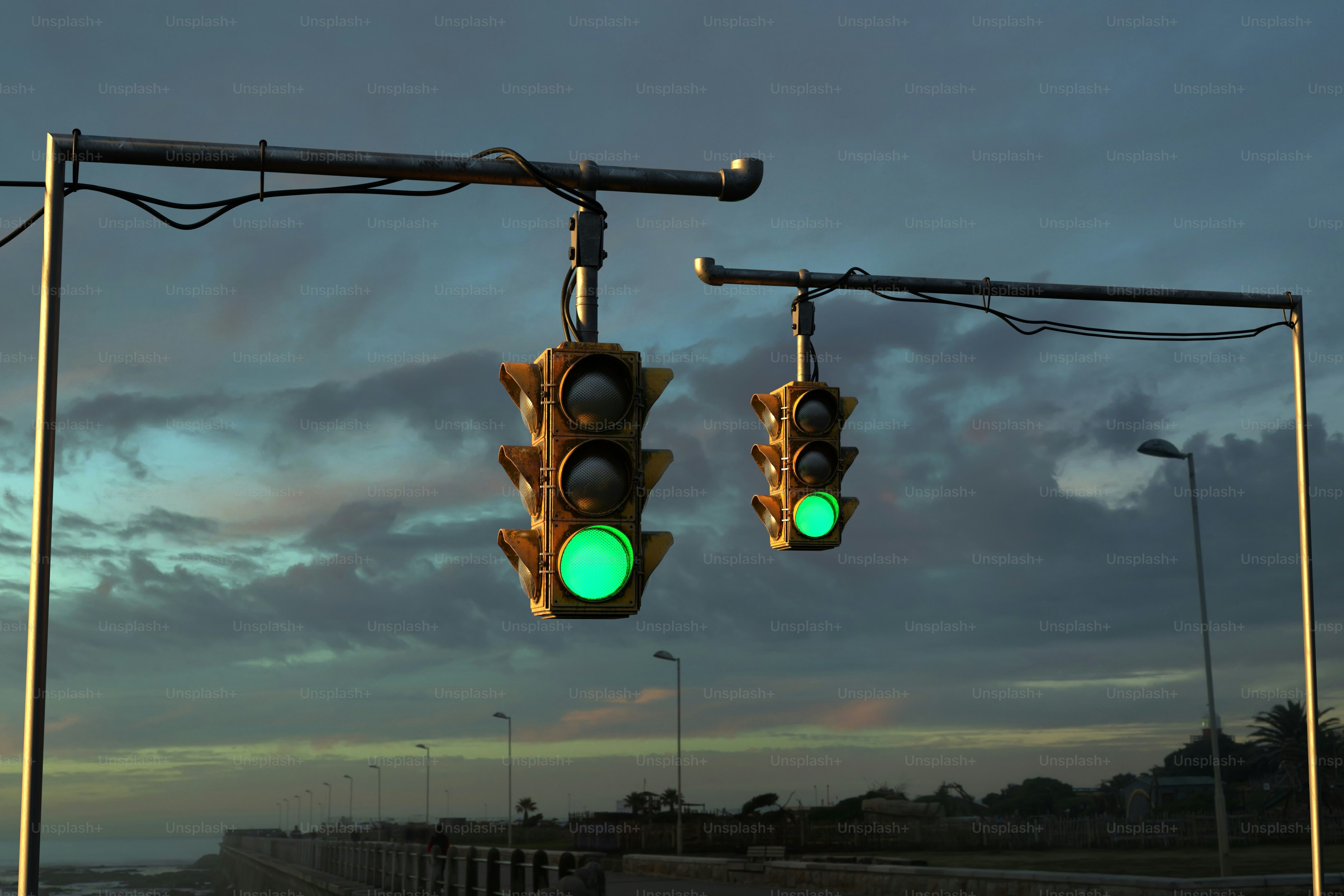 A traffic light with two green lights hanging from it's sides photo ...