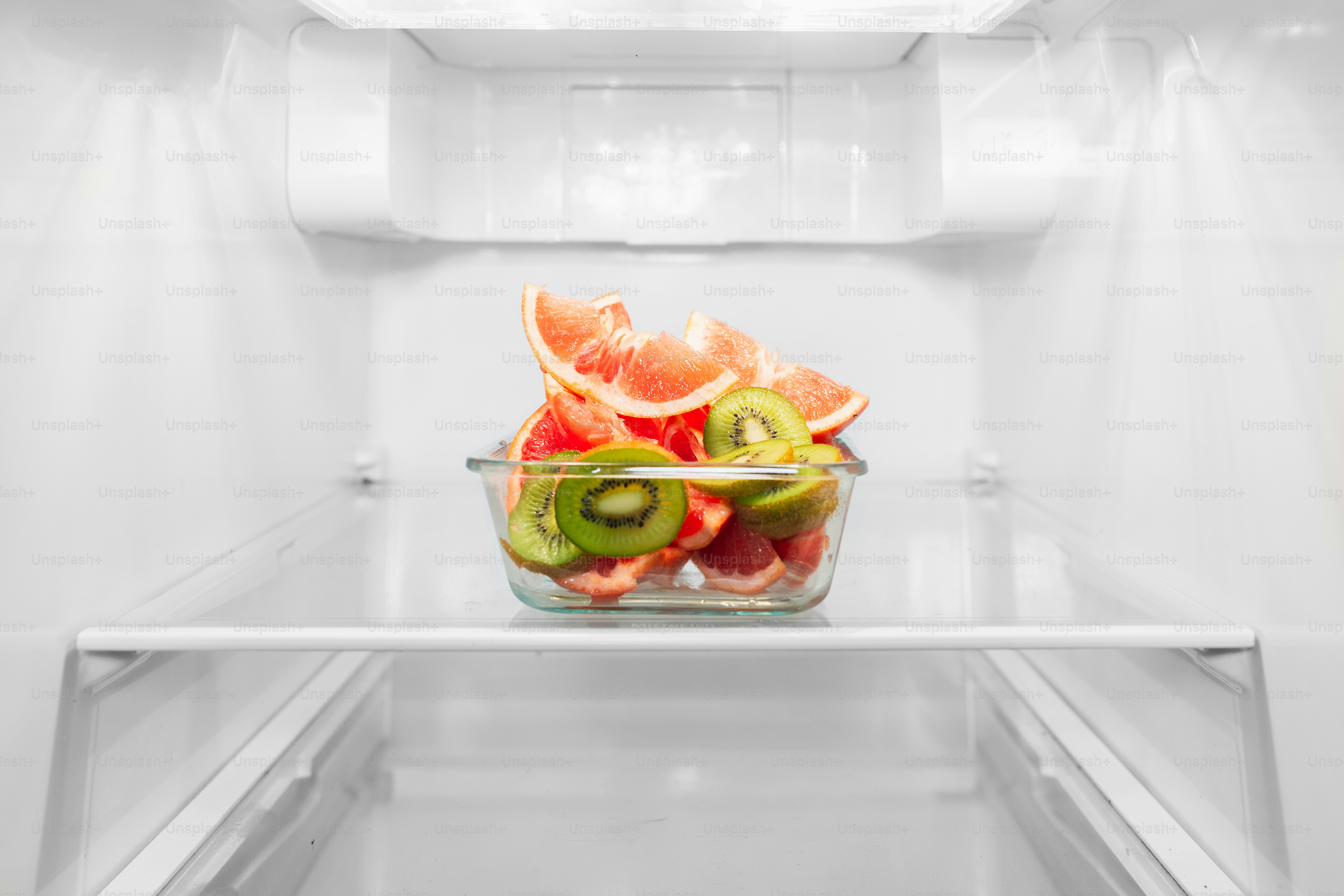 A bowl of fruit inside of a refrigerator photo – Fruits Image on Unsplash