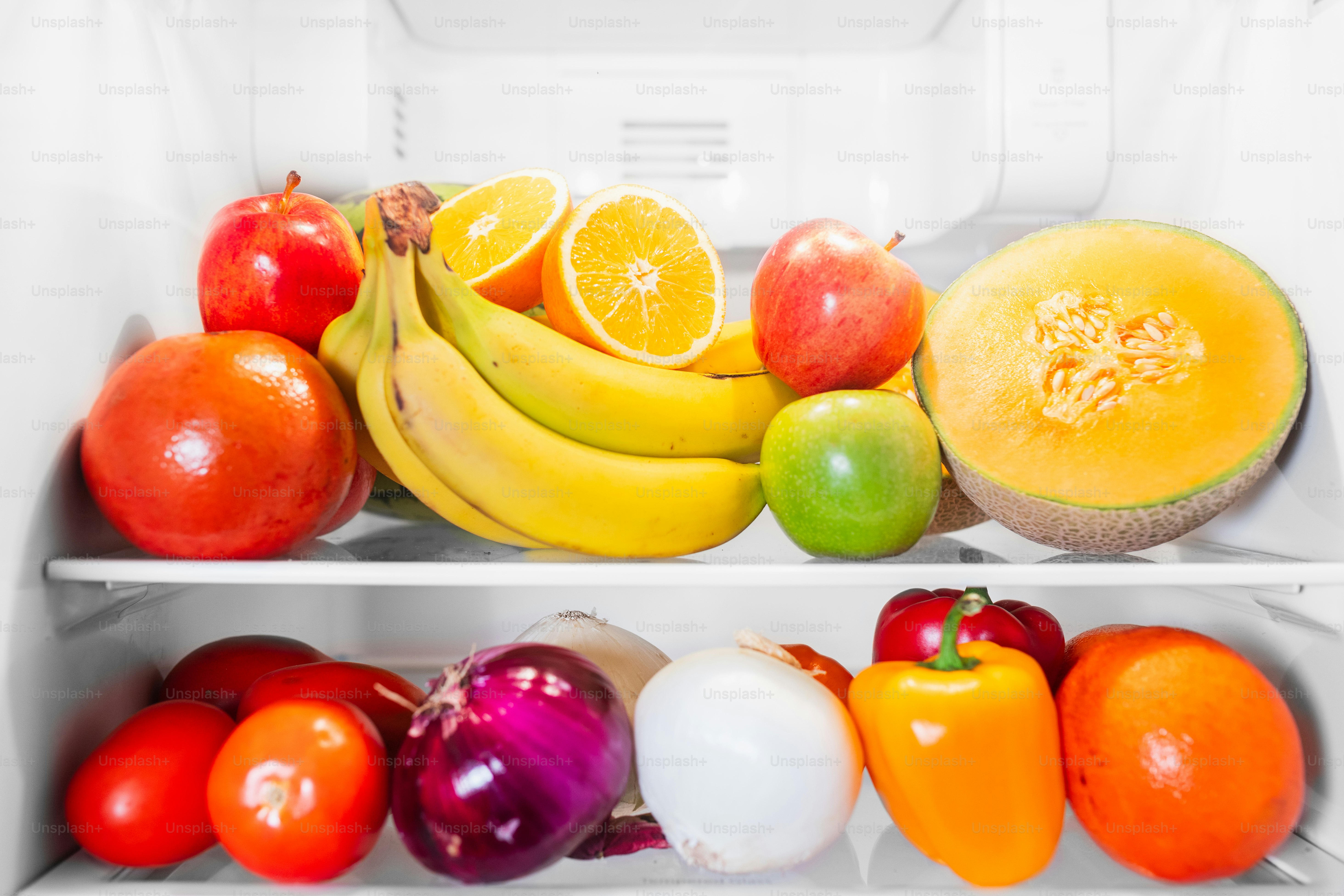 A refrigerator filled with lots of different types of fruits and ...