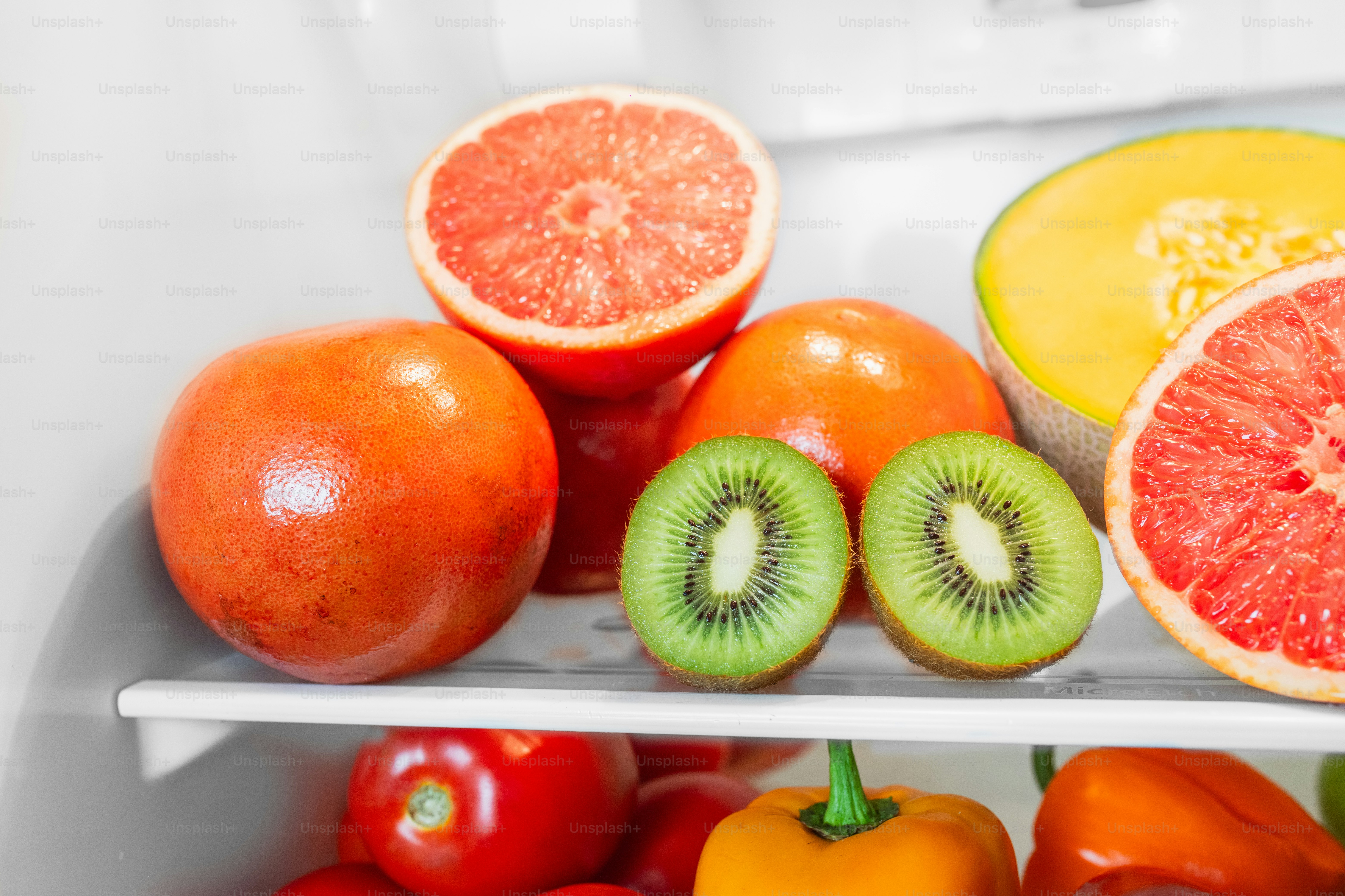 A refrigerator filled with lots of different types of fruits and ...