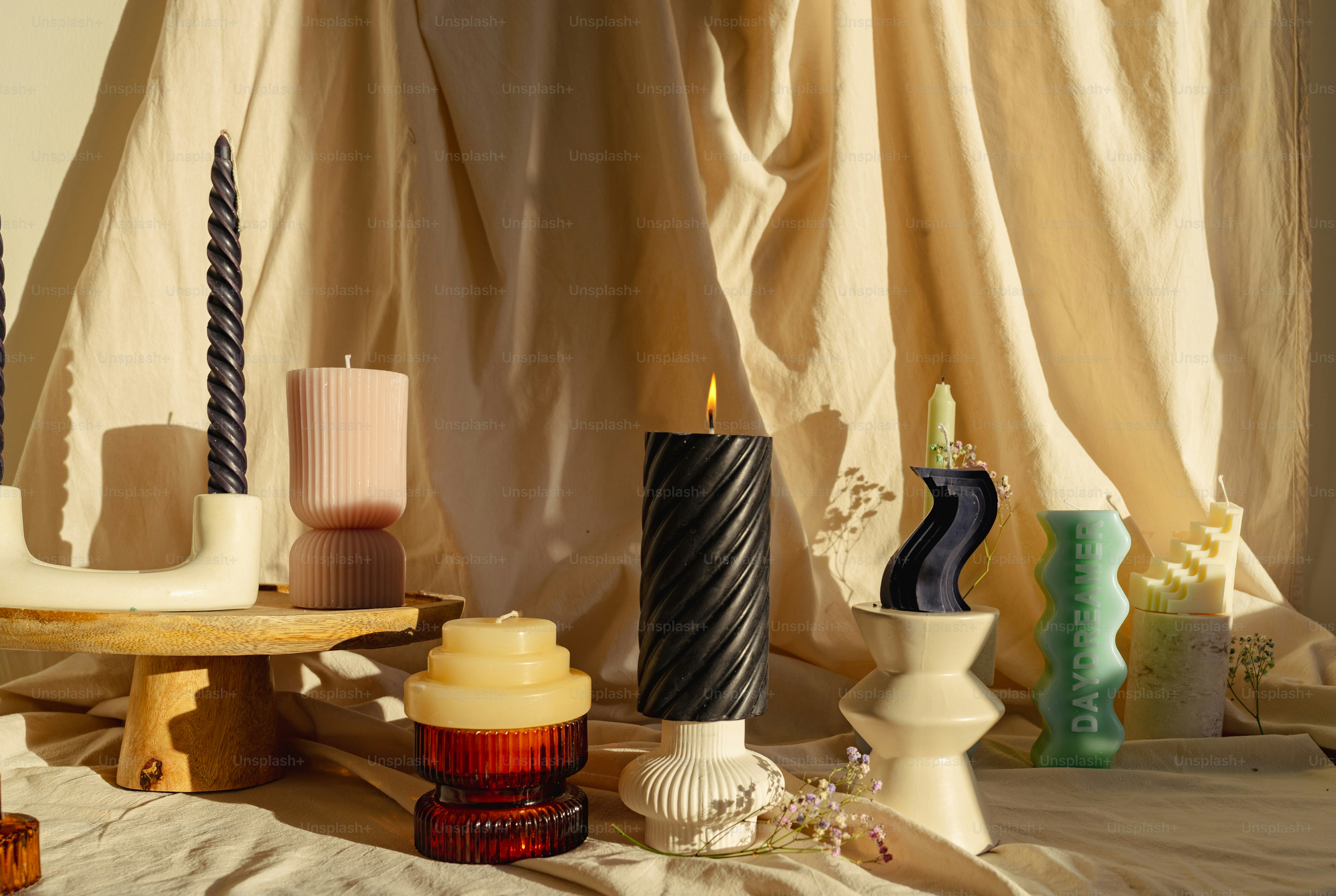 A table topped with lots of candles next to a curtain photo – Candles ...