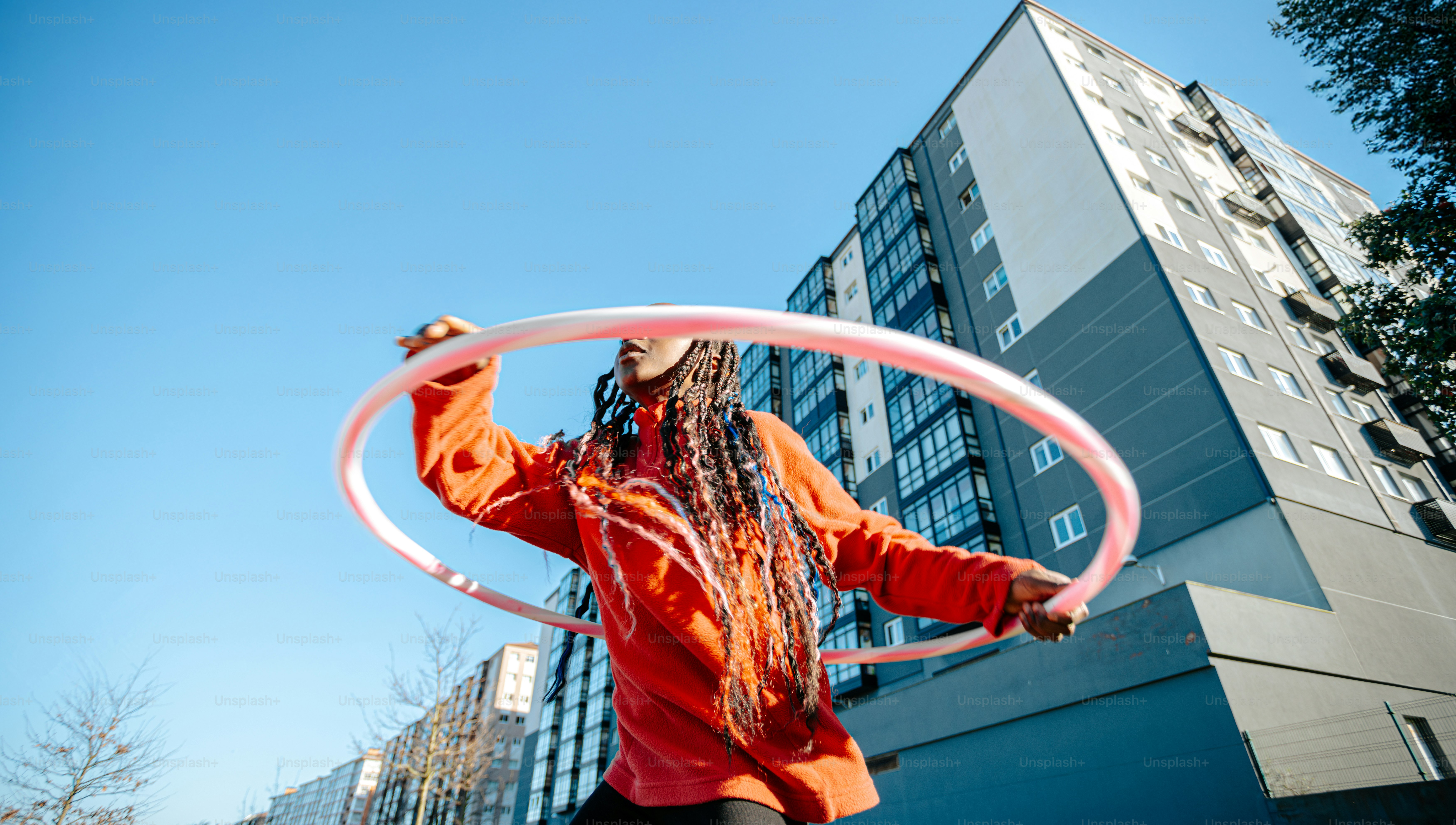 A person with a hula hoop in front of a building photo – Distorted view ...